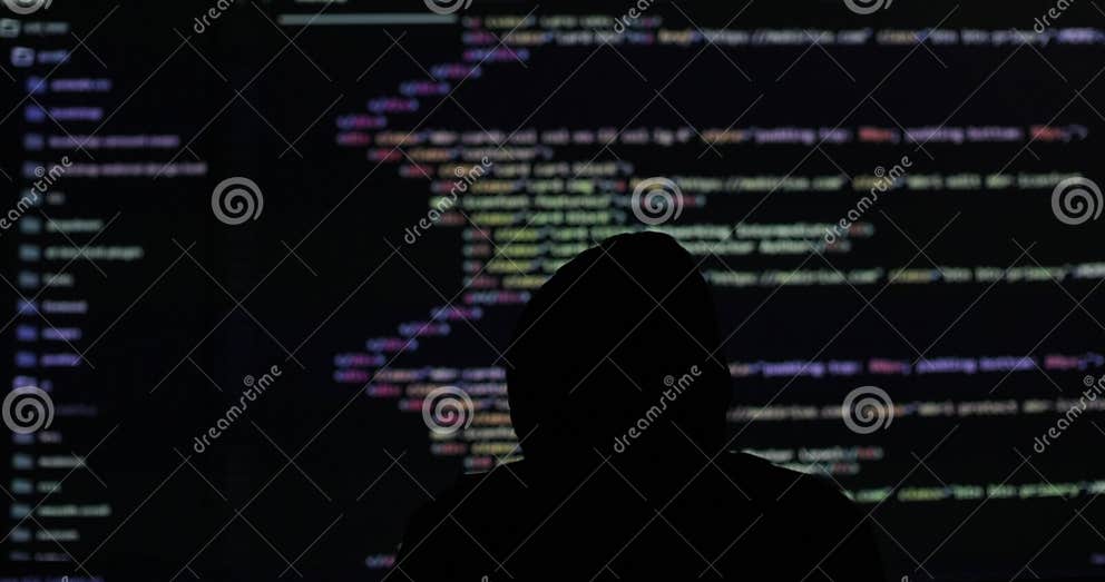 Man Hacker Working in Dark Abstract Room. Programming Code on a Large ...