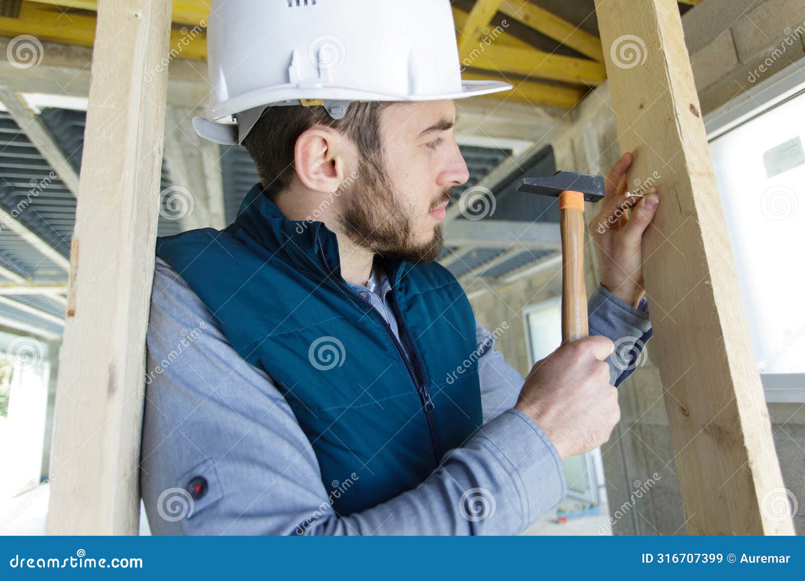 Man with hammer and nail stock image. Image of property - 316707399