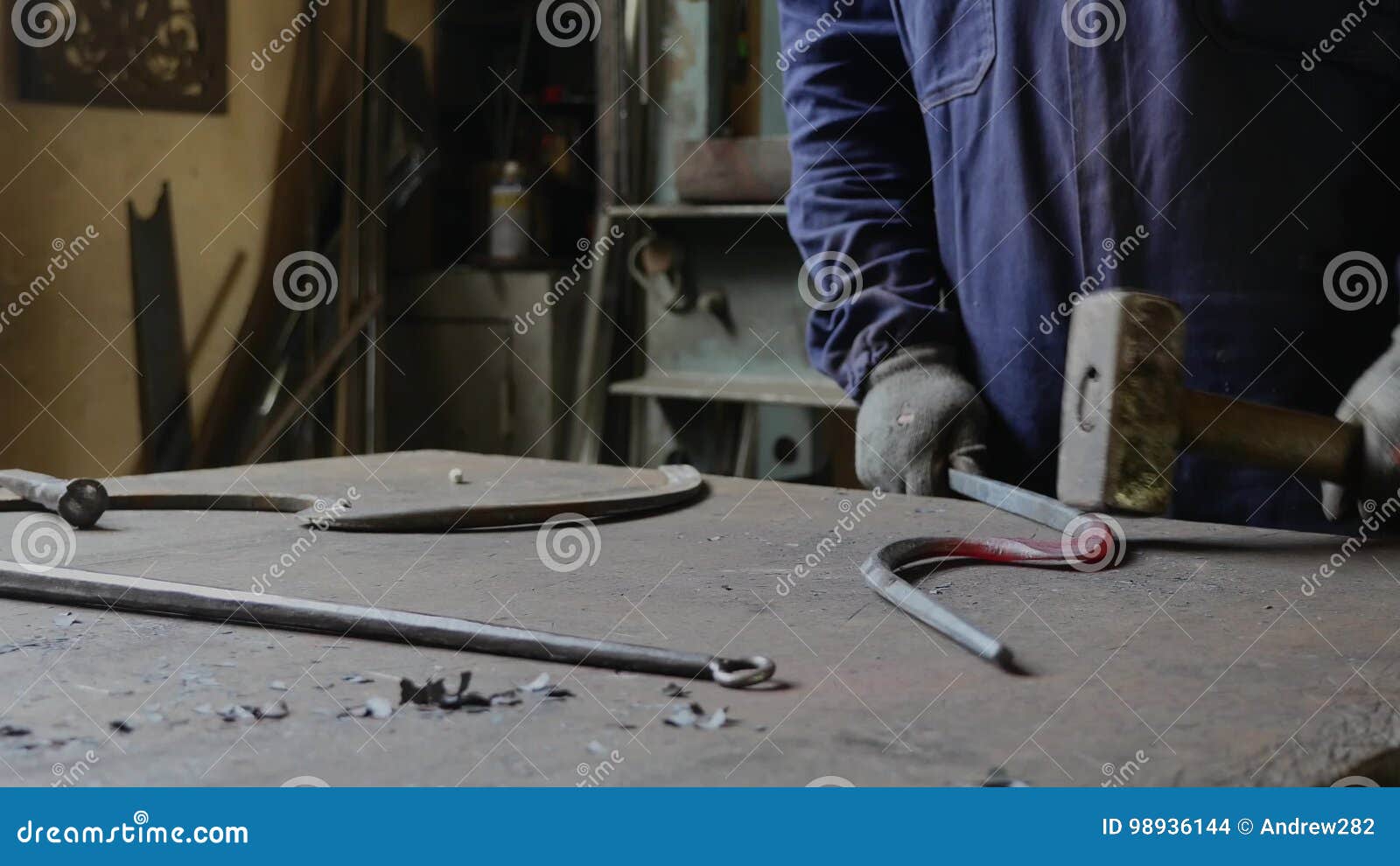 A Man is Hammering an Iron Hook with a Hammer Stock Photo - Image of ...