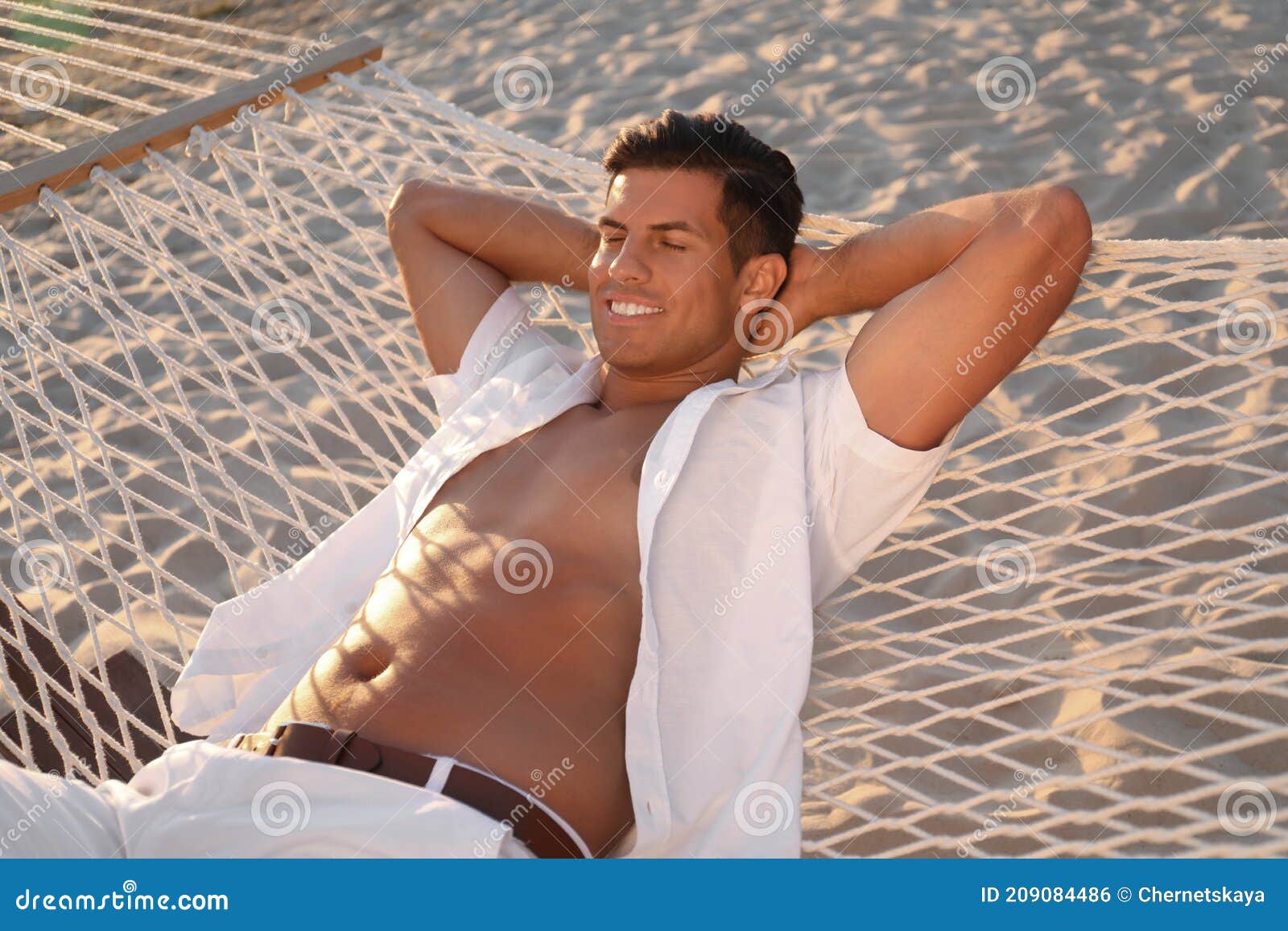 Man Relaxing in Hammock on Beach at Sunset Stock Photo - Image of calm ...