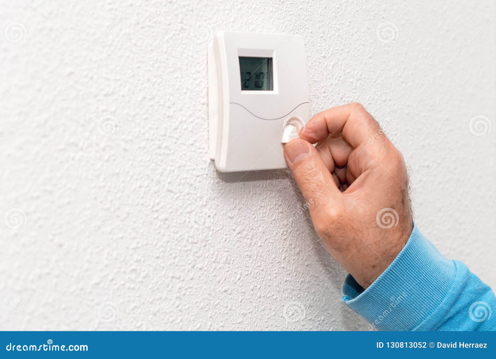 Man Hand Adjusting Thermostat at Home. Celsius Temperature Scale. Stock ...