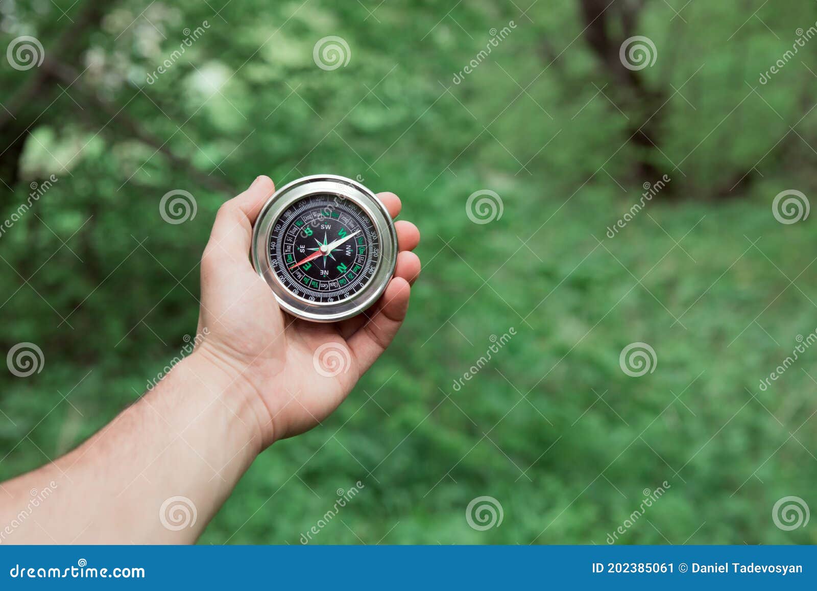 Man hand compass in forest stock image. Image of discovery - 202385061