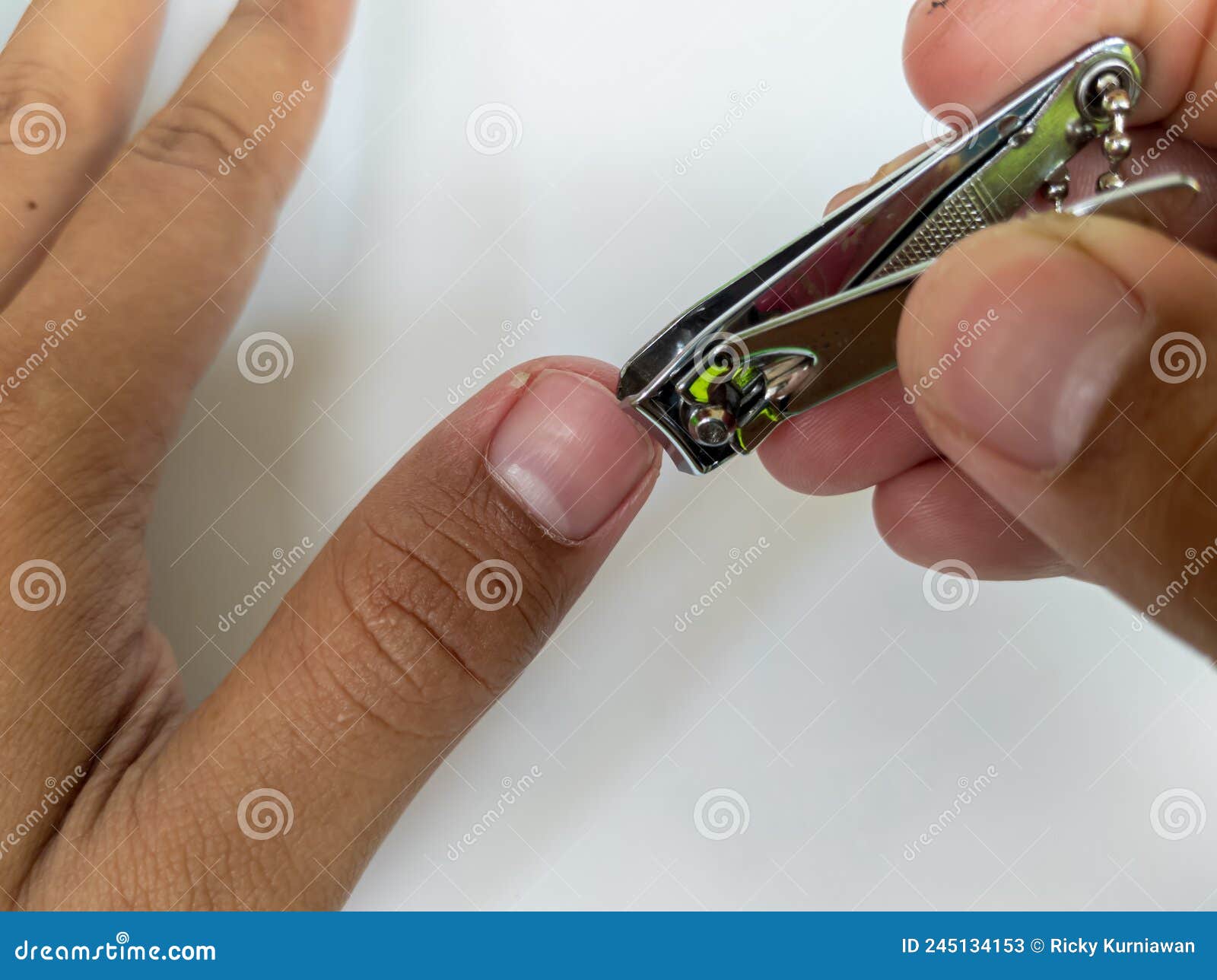 Man Hand Cutting Nails on a White Background Stock Image - Image of ...