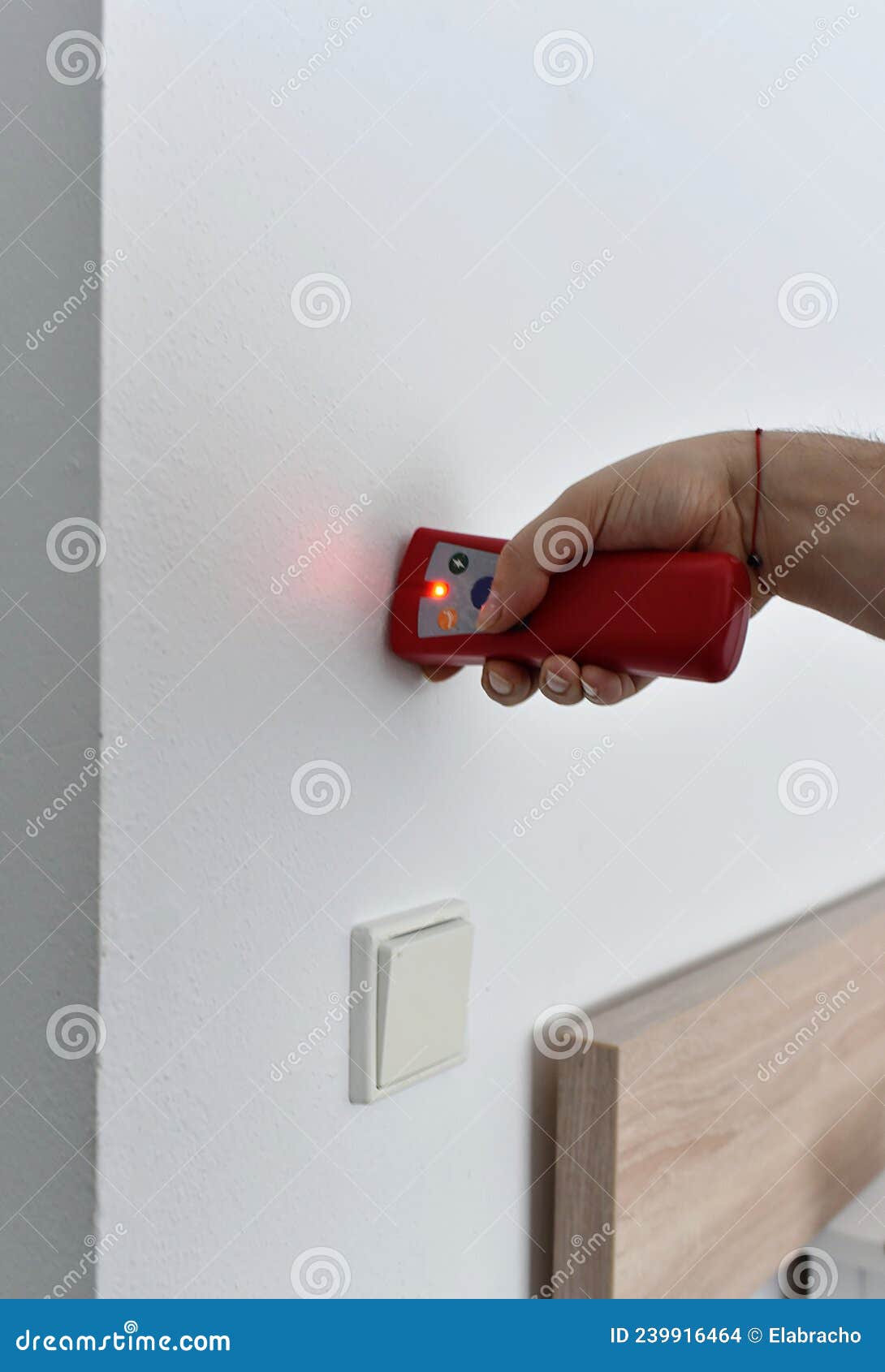 Man Detects Wires in the Wall. Contactless Voltage Tester. Stock Photo ...