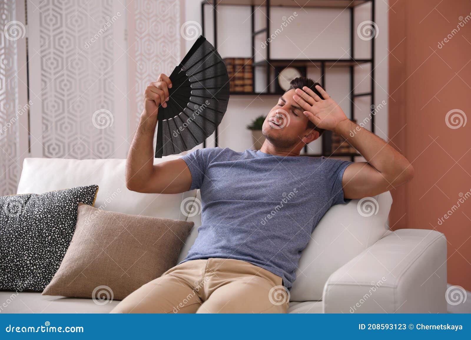 Man with Hand Fan Sitting on Sofa. Summer Season Stock Image - Image of ...
