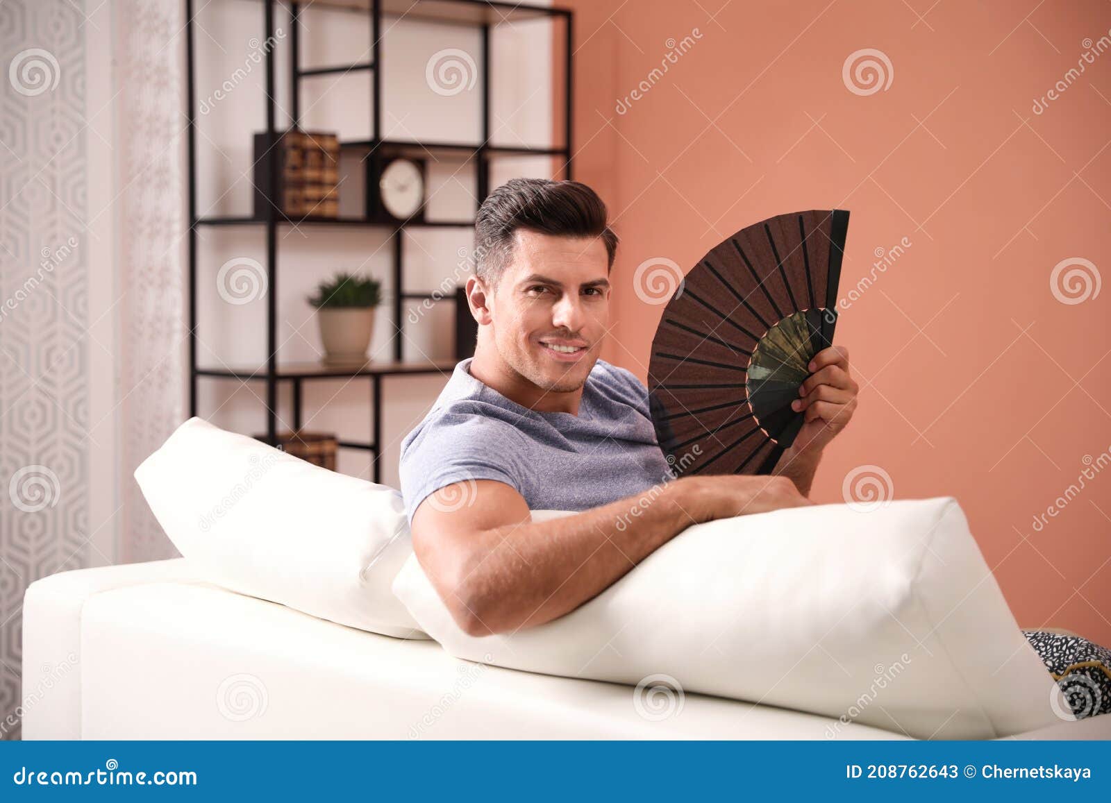 Man with Hand Fan Sitting on Sofa. Summer Season Stock Image - Image of ...