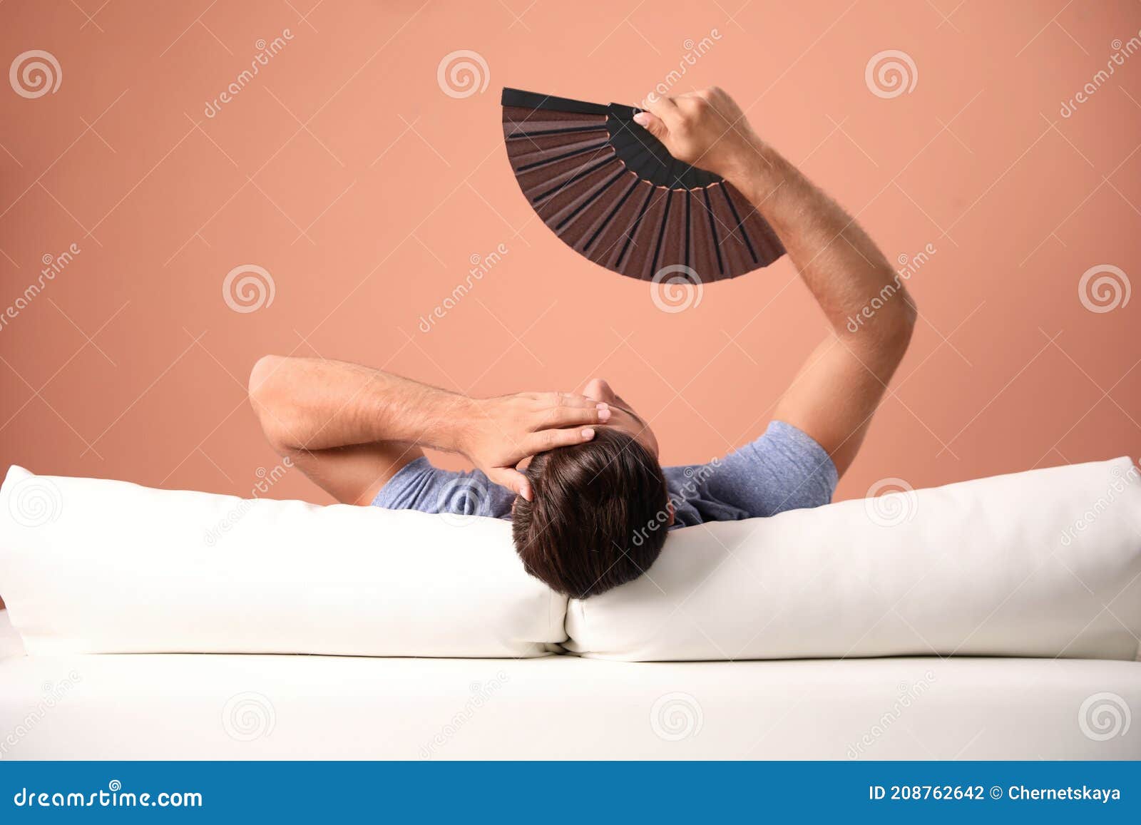 Man with Hand Fan on Sofa. Summer Season Stock Photo - Image of fresh ...
