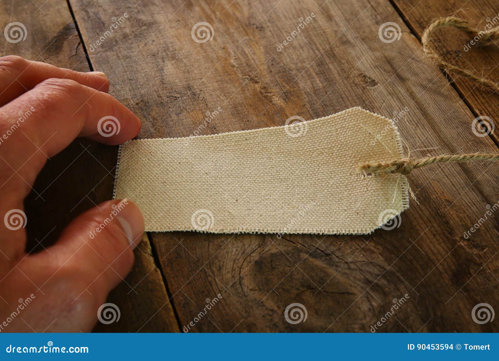 Man Hand Holding Canvas Ticket Over Wooden Table. Stock Photo - Image ...
