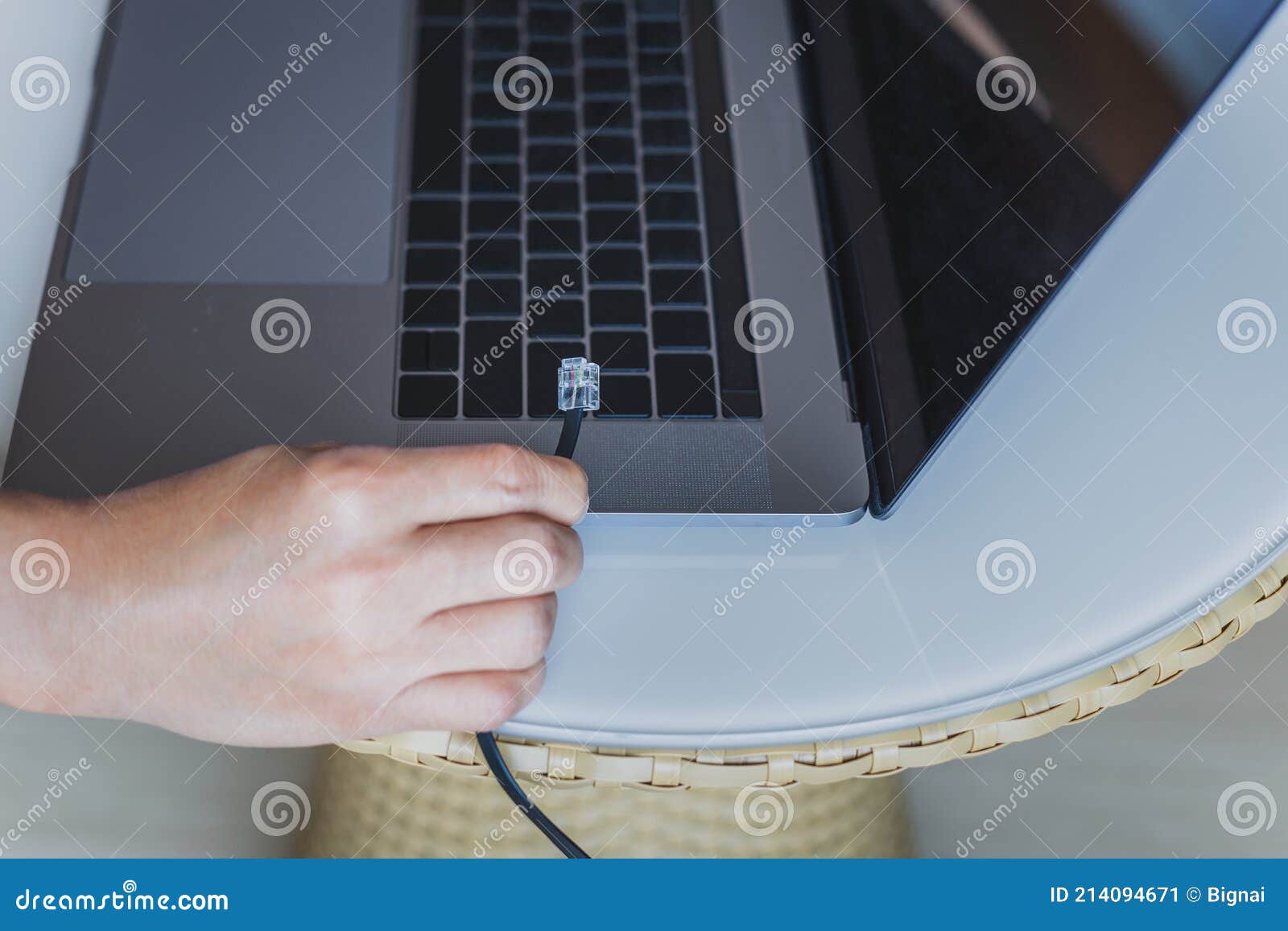 Man Hand Holding Internet Cable Wire with Laptop in Background. Stock ...