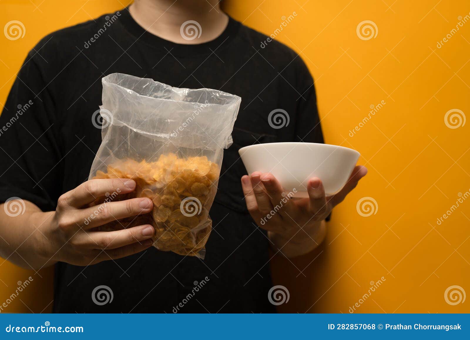 Man Hand Holding Opened Plastic Pack of Corn Flakes and Bowl Isolated ...