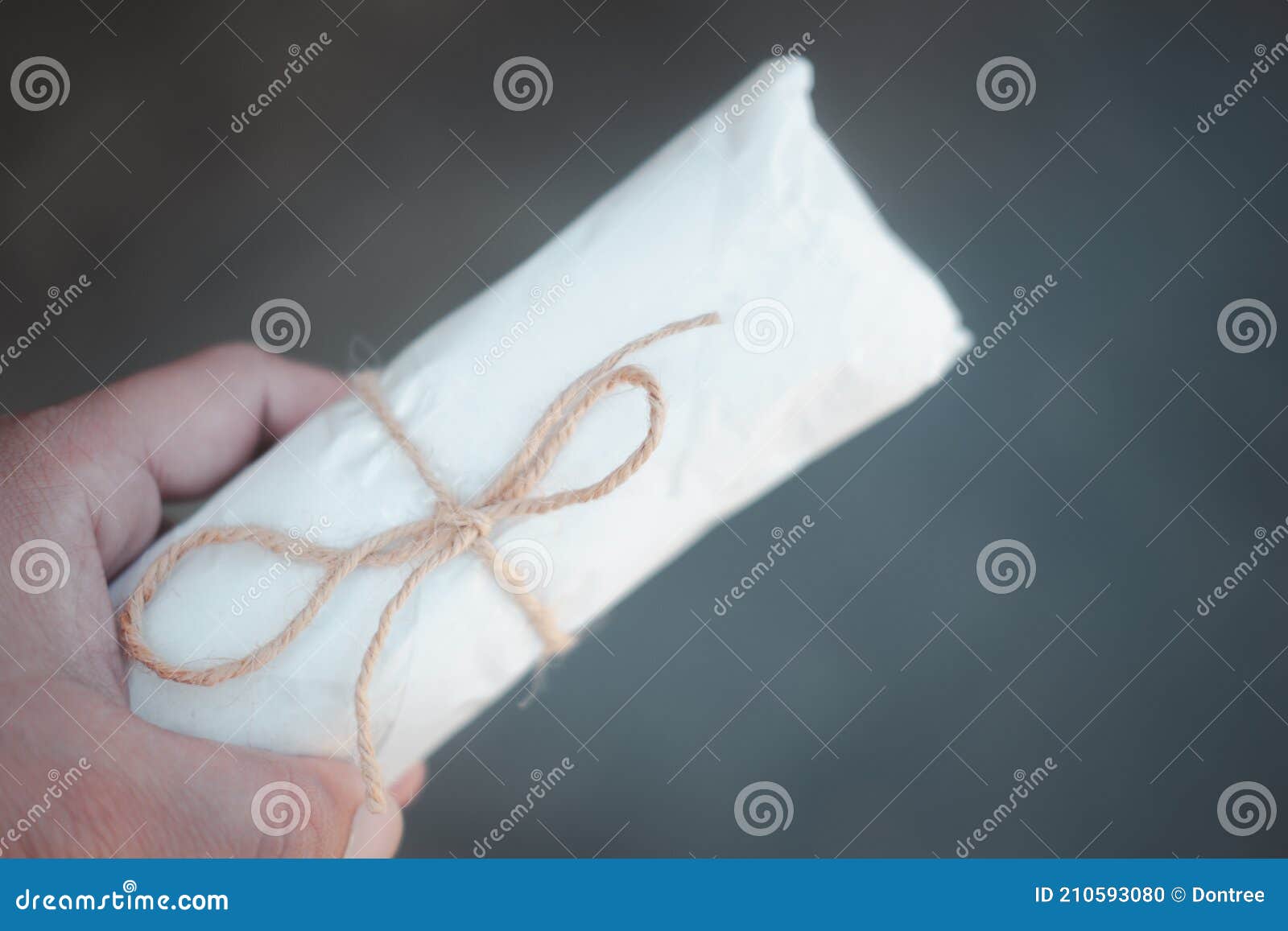Man Hand Holding Paper Packaging Wrapped by Rope. Stock Photo - Image ...