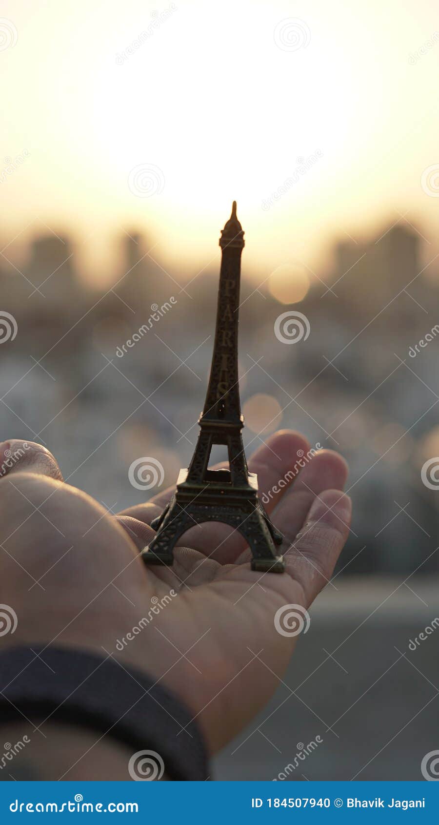 Man Hand Holding Small Eiffel Tower Over Hand Stock Photo - Image of ...