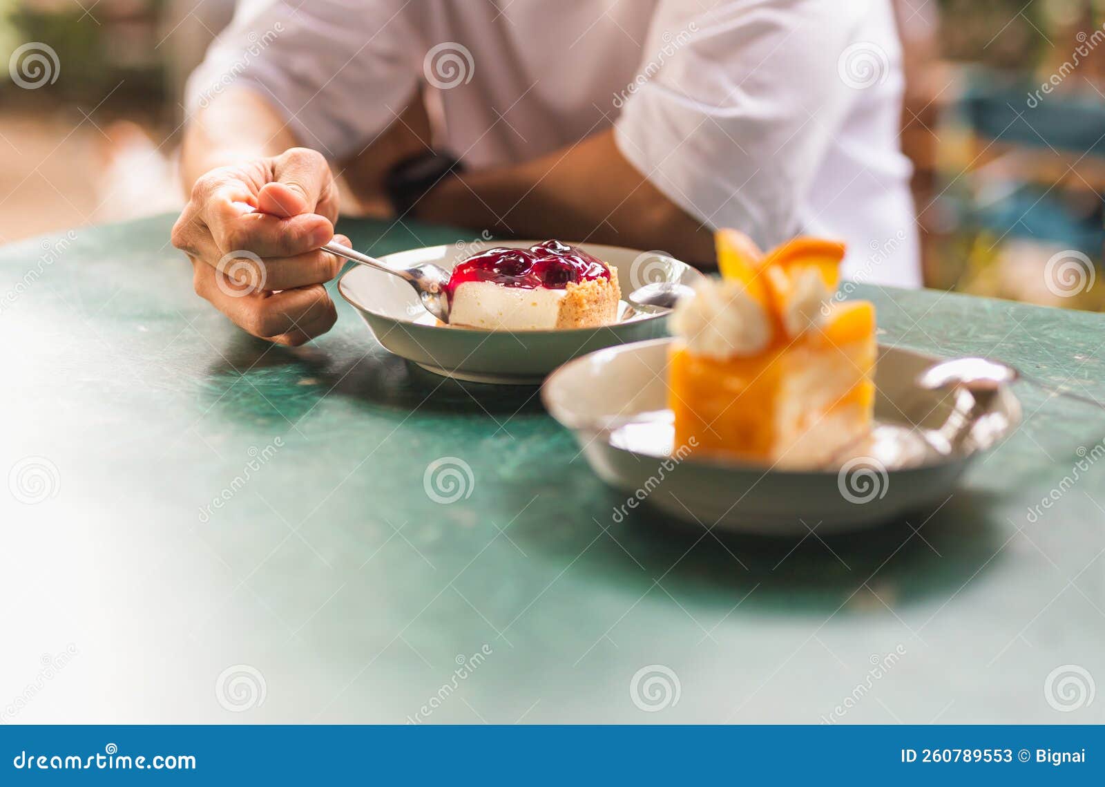 Man Hand Holding a Spoon Eating Cheesecake in Cafe. Stock Image - Image ...