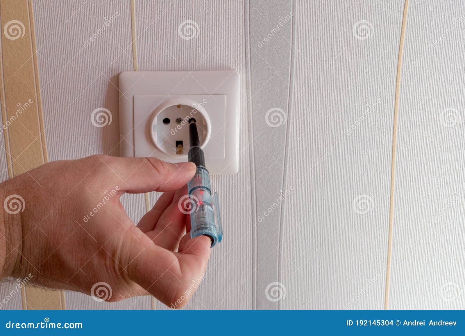 Hand Holds Handle of Indicator Screwdriver, Inserted into Electrical ...