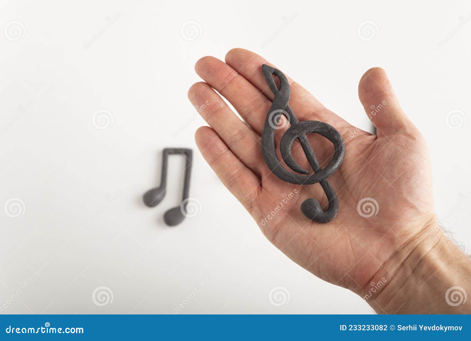 Man Hand Holds Musical Note Treble Clef and Notes Background. Music ...