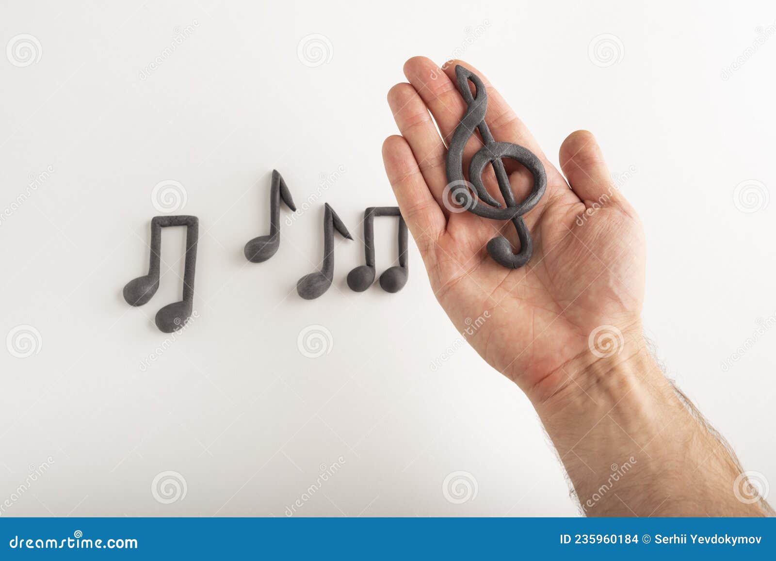 Man Hand Holds Musical Note Treble Clef and Notes Background. Music ...