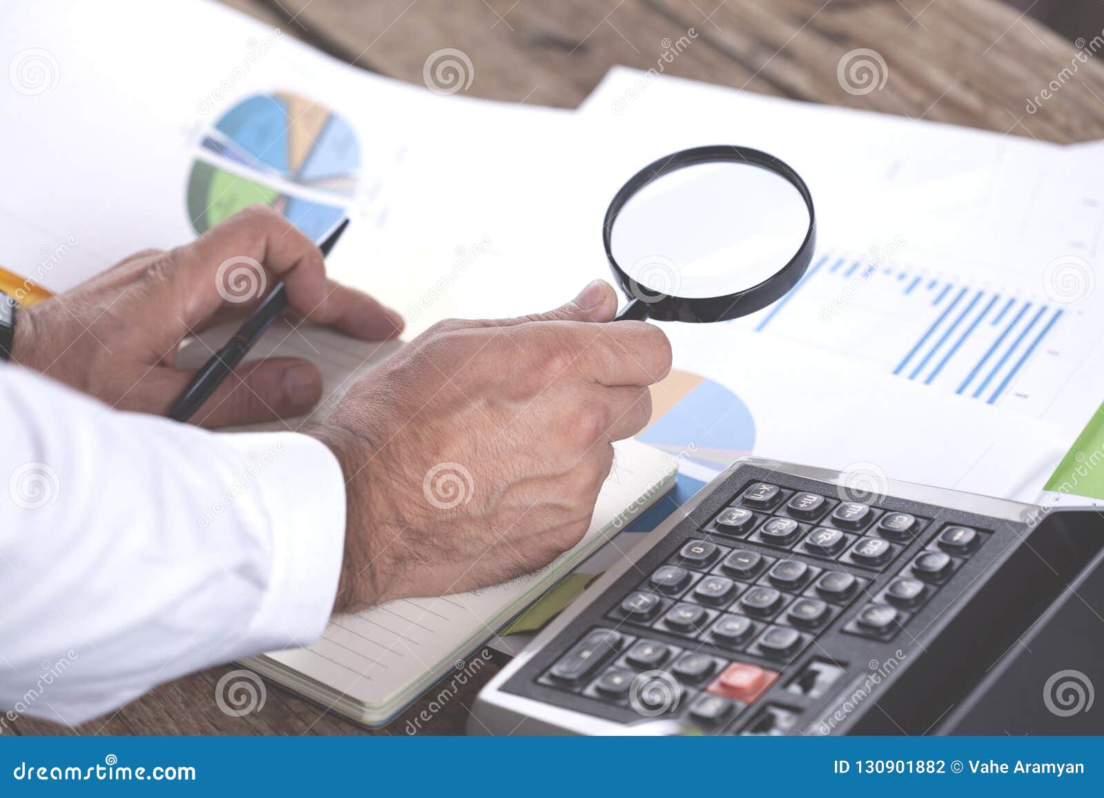 Man Hand Magnifier with Calculator and Graph Stock Photo - Image of ...