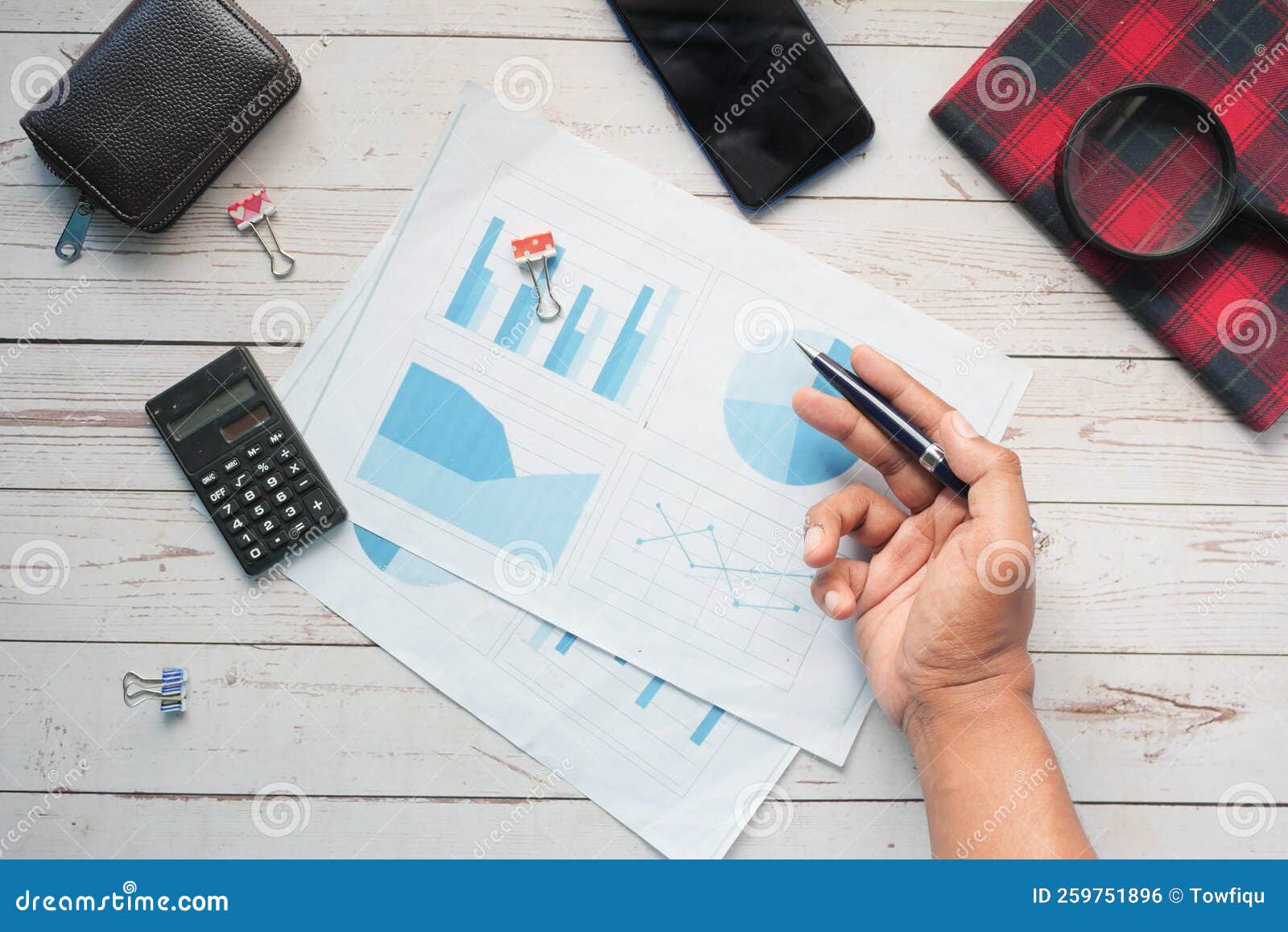 Overhead View of Man Hand with Pen Analyzing Bar Chart on Paper Stock ...