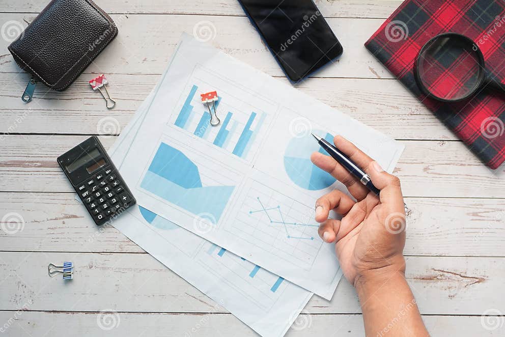 Overhead View of Man Hand with Pen Analyzing Bar Chart on Paper Stock ...