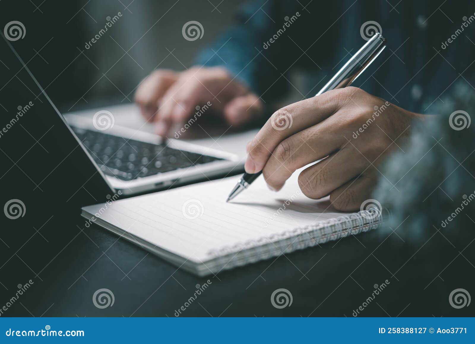 Man Hand with Pen Writing on Notebook with Computer Laptop at Desk ...