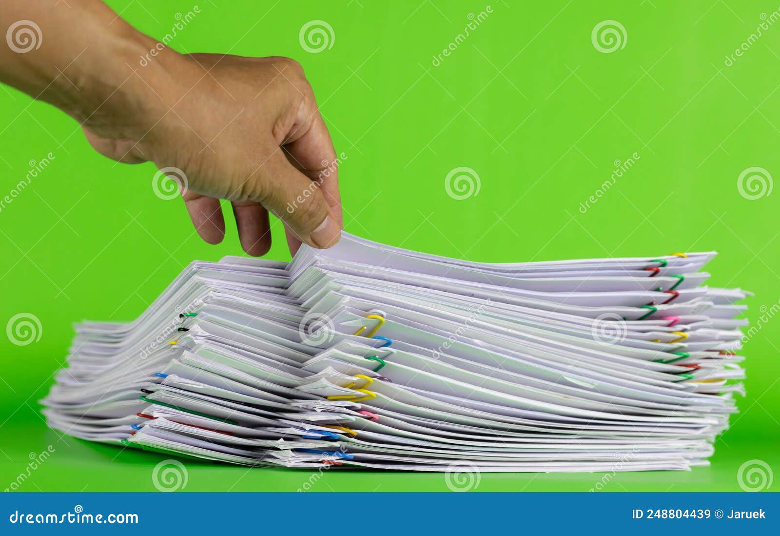 Man Hand Picking Up Paper in Stack Documents on Green Stock Image ...