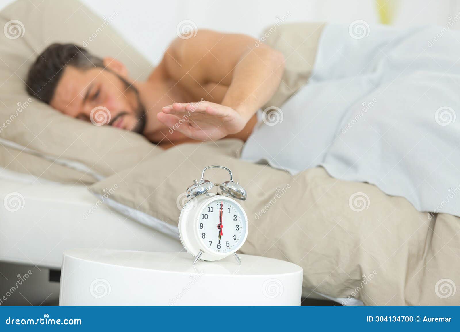 Man with Hand Poised Over Alarmclock To Silence it Stock Photo - Image ...