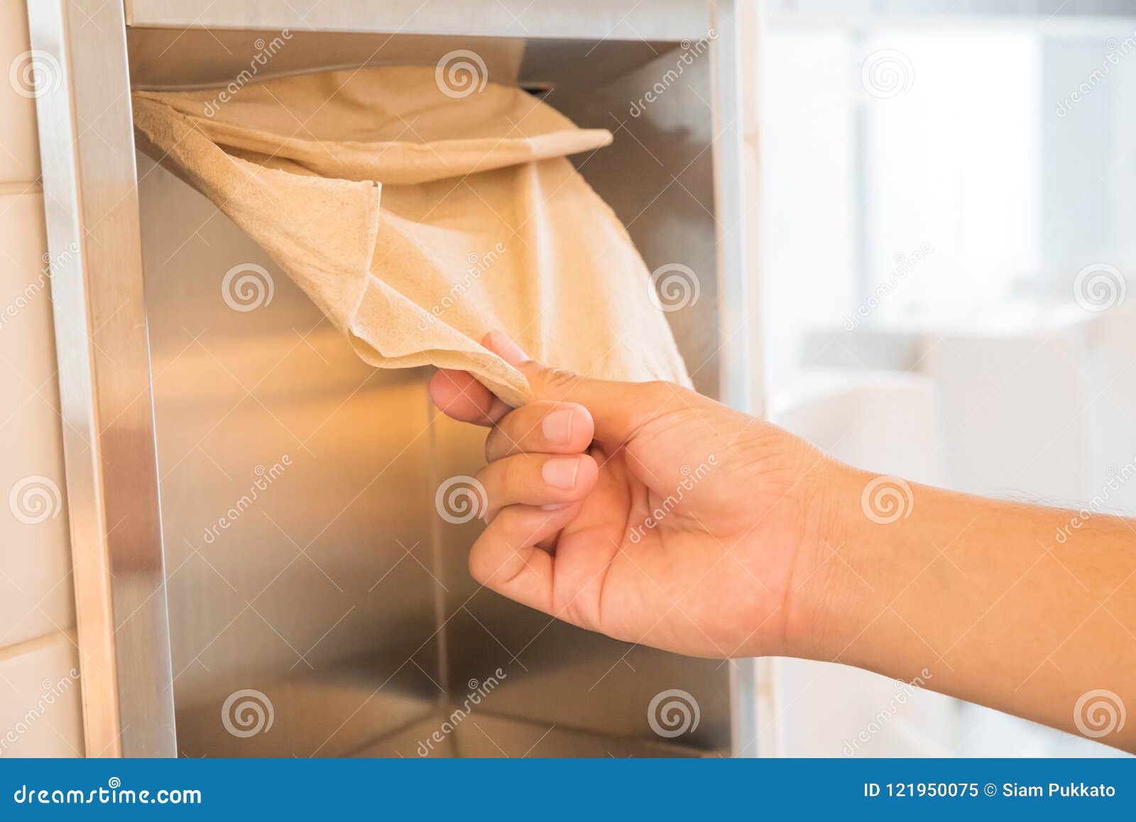 Man Hand Pulling a Brown Tissue from Tissue Box in the Restroom. Stock ...