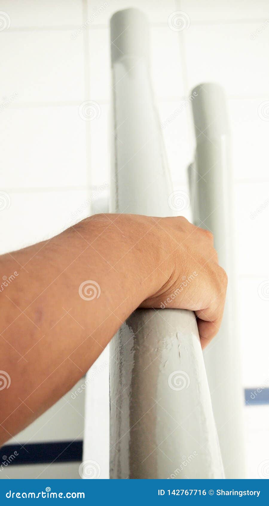 Man is hand on rail stock photo. Image of closeup, rail - 142767716