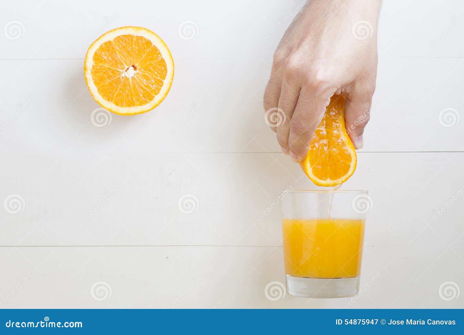 Man Hand Squeezing Orange on Orange Juice Glass Stock Image - Image of ...