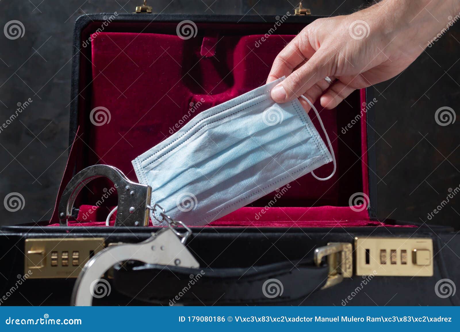 Caucasian Man Hand Stuffing Face Mask into Security Briefcase with ...