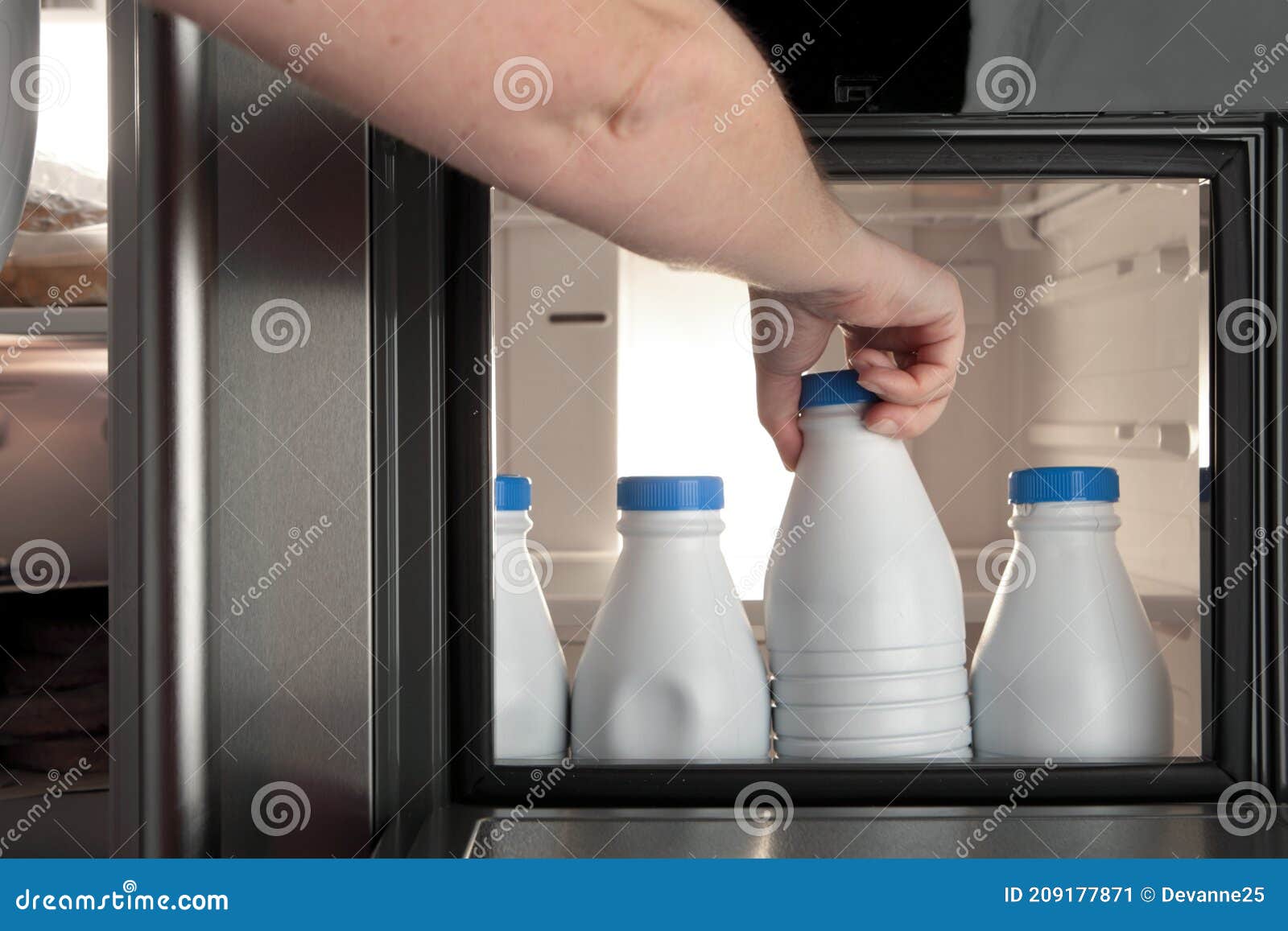 Man Hand Taking a Bottle of Milk from a Fridge Stock Image - Image of ...