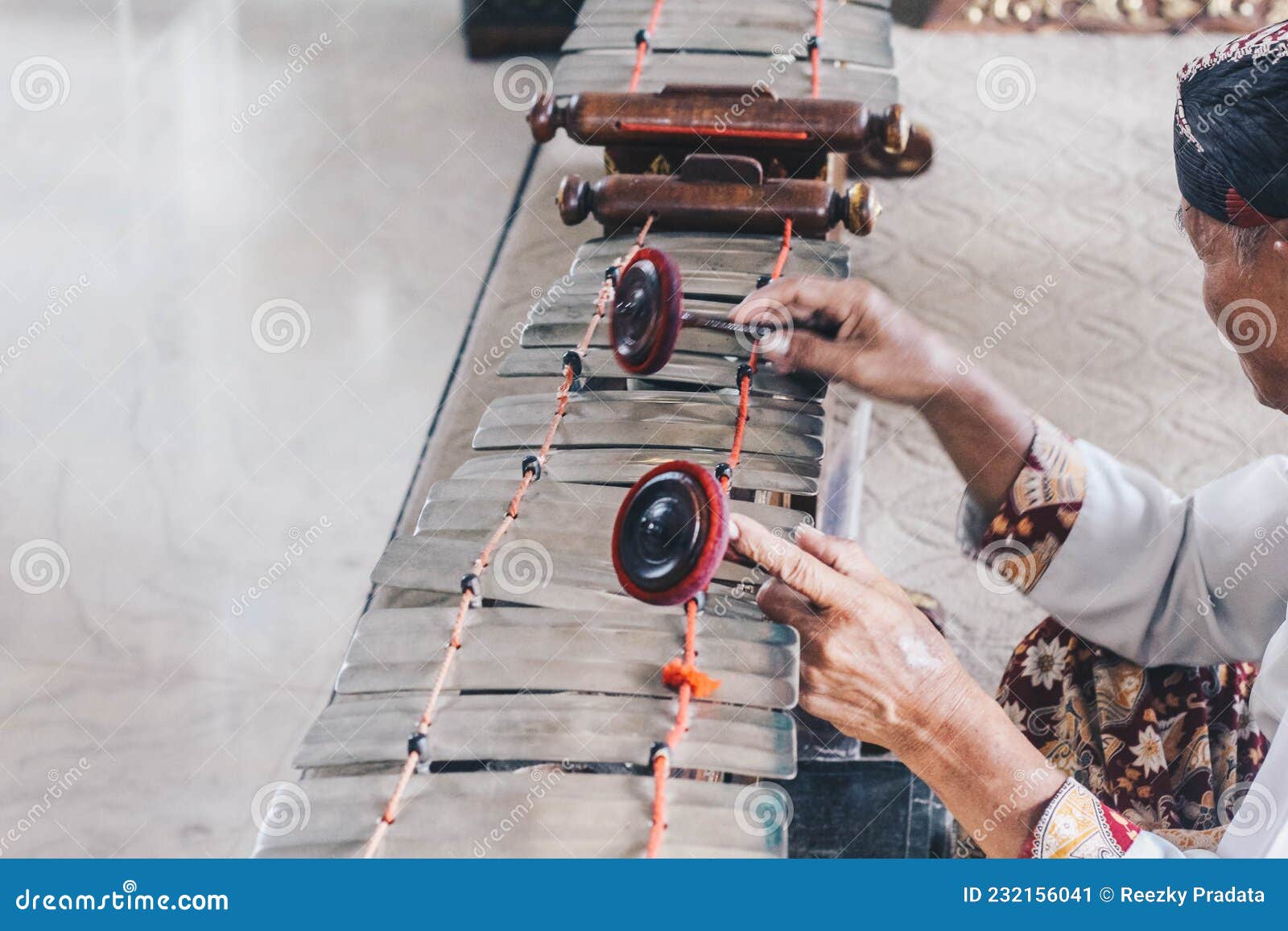A Man Hand Use Batik Playing Gamelan Gender or Slenthem Stock Image ...