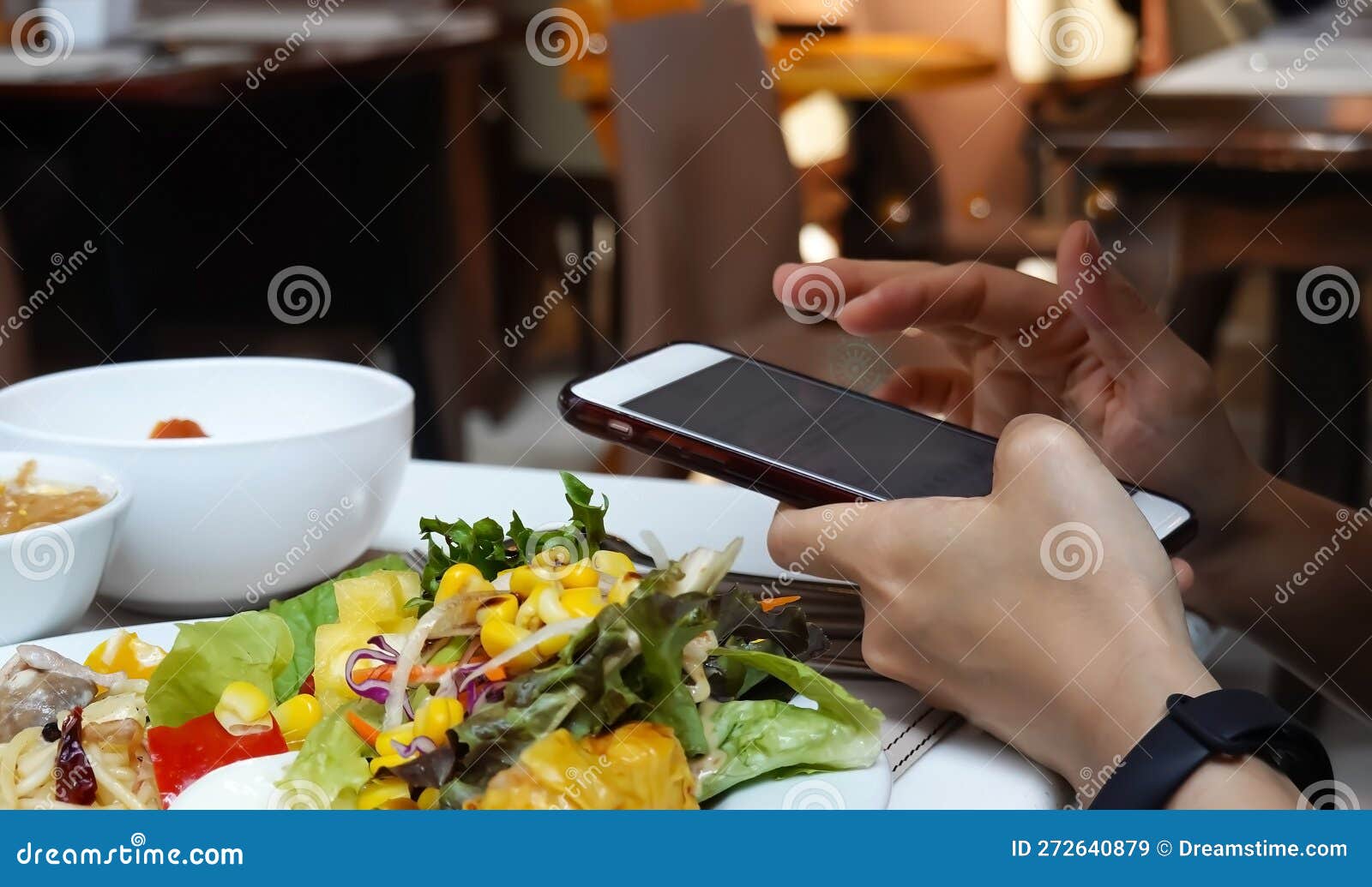 Man Hand Using or Looking at His Smartphone and Having Lunch in the ...