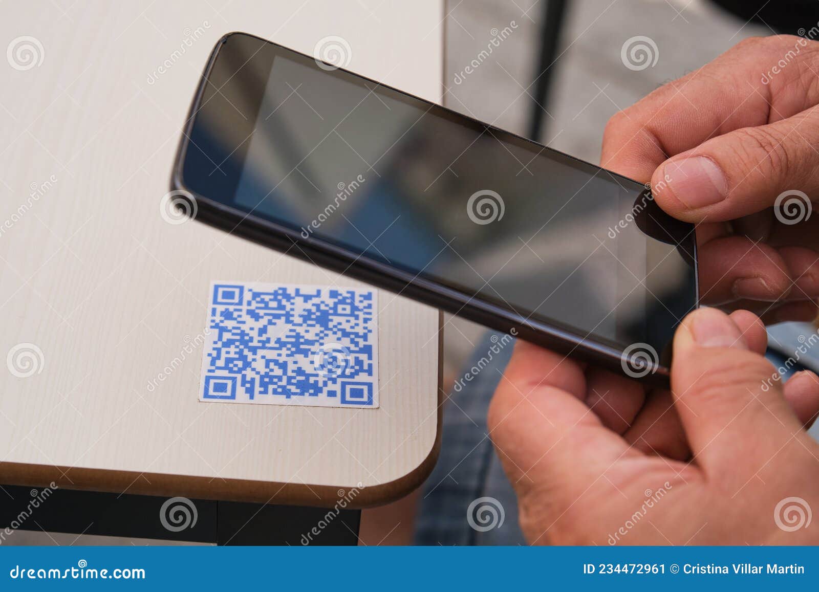 Man Hand Using the Smartphone To Scan the QR Code in a Bar Table. Stock ...