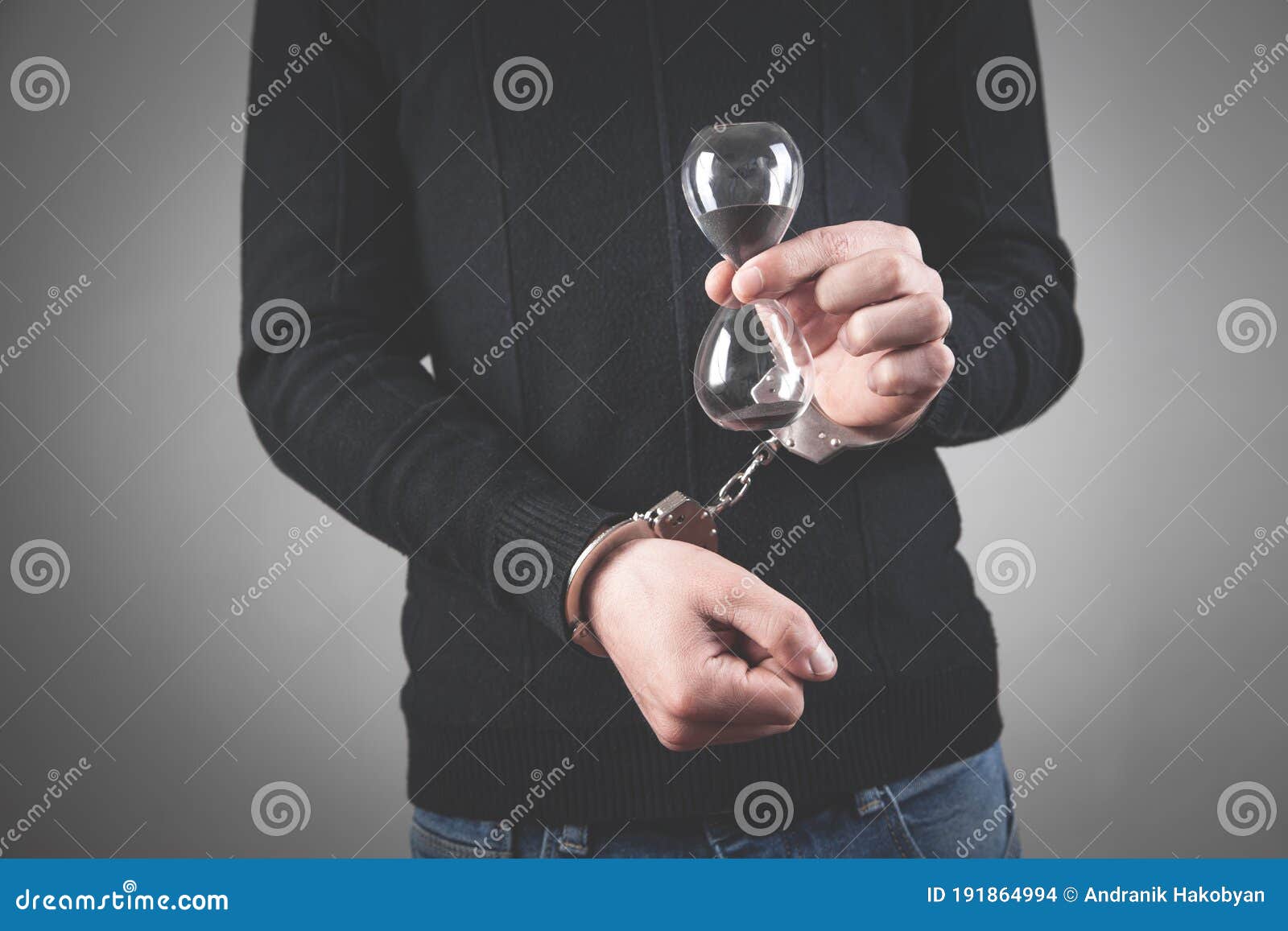 Man with Handcuffs Holding Hourglass Stock Photo - Image of time, sand ...