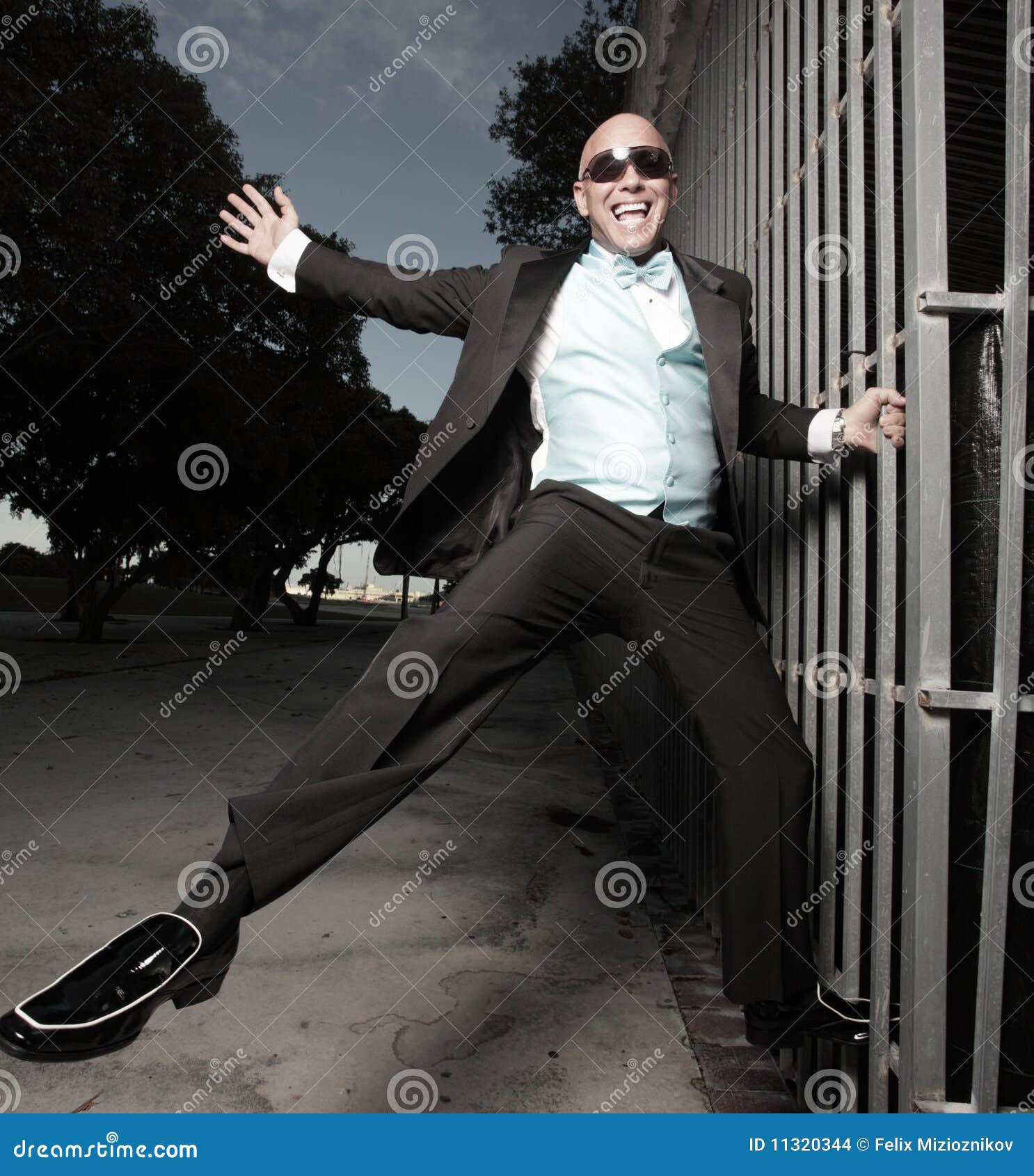 Man Handing from a Metal Gate Stock Photo - Image of forties, caucasian ...