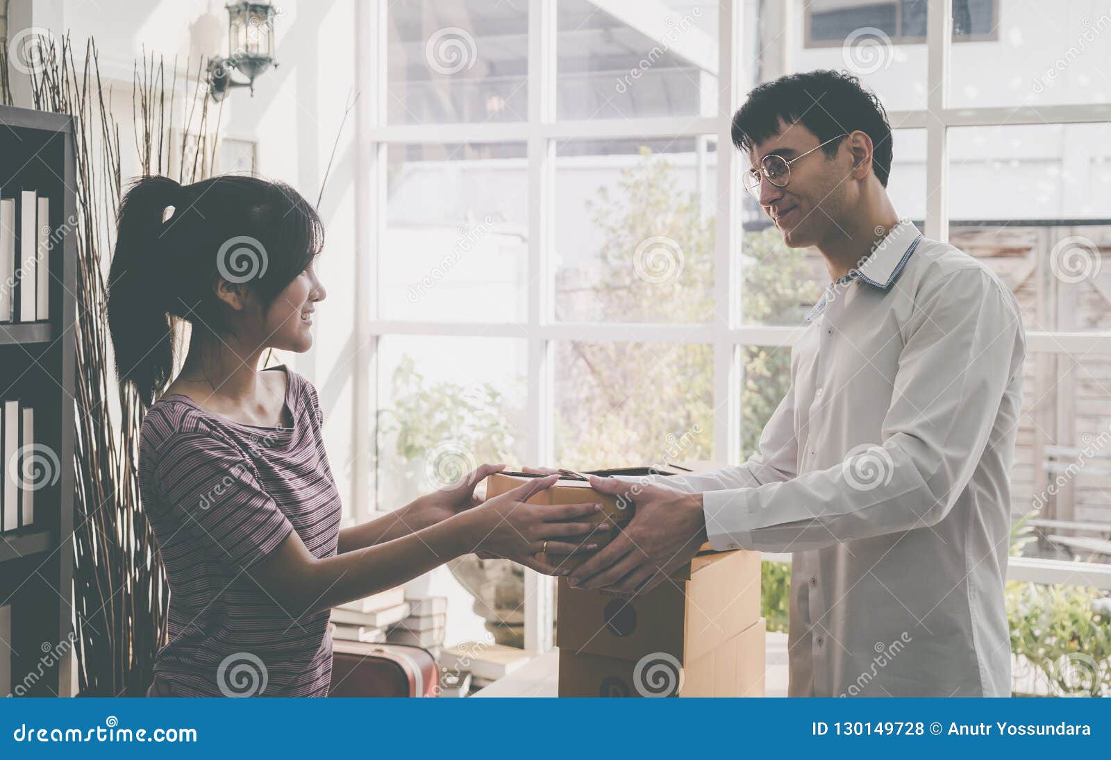 Man Handing Packages To a Woman Stock Photo - Image of parcel, giving ...