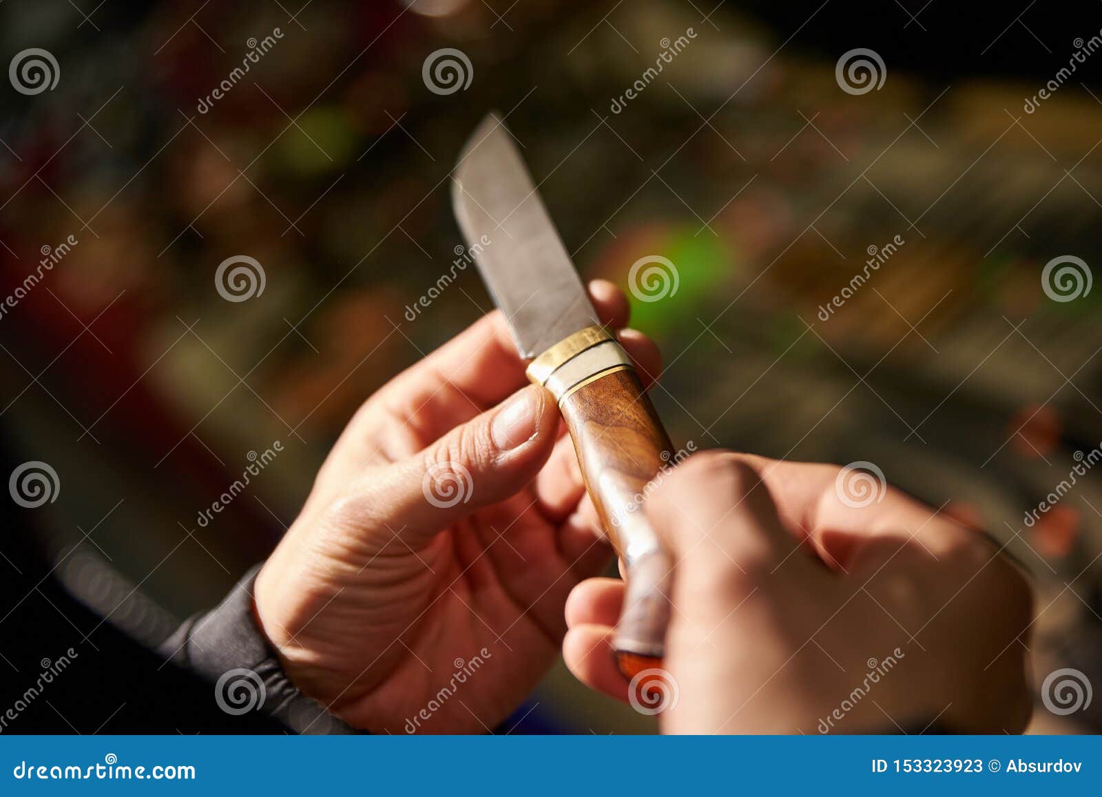 MAN HANDS HUNTING KNIFE stock image. Image of male, blade - 153323923