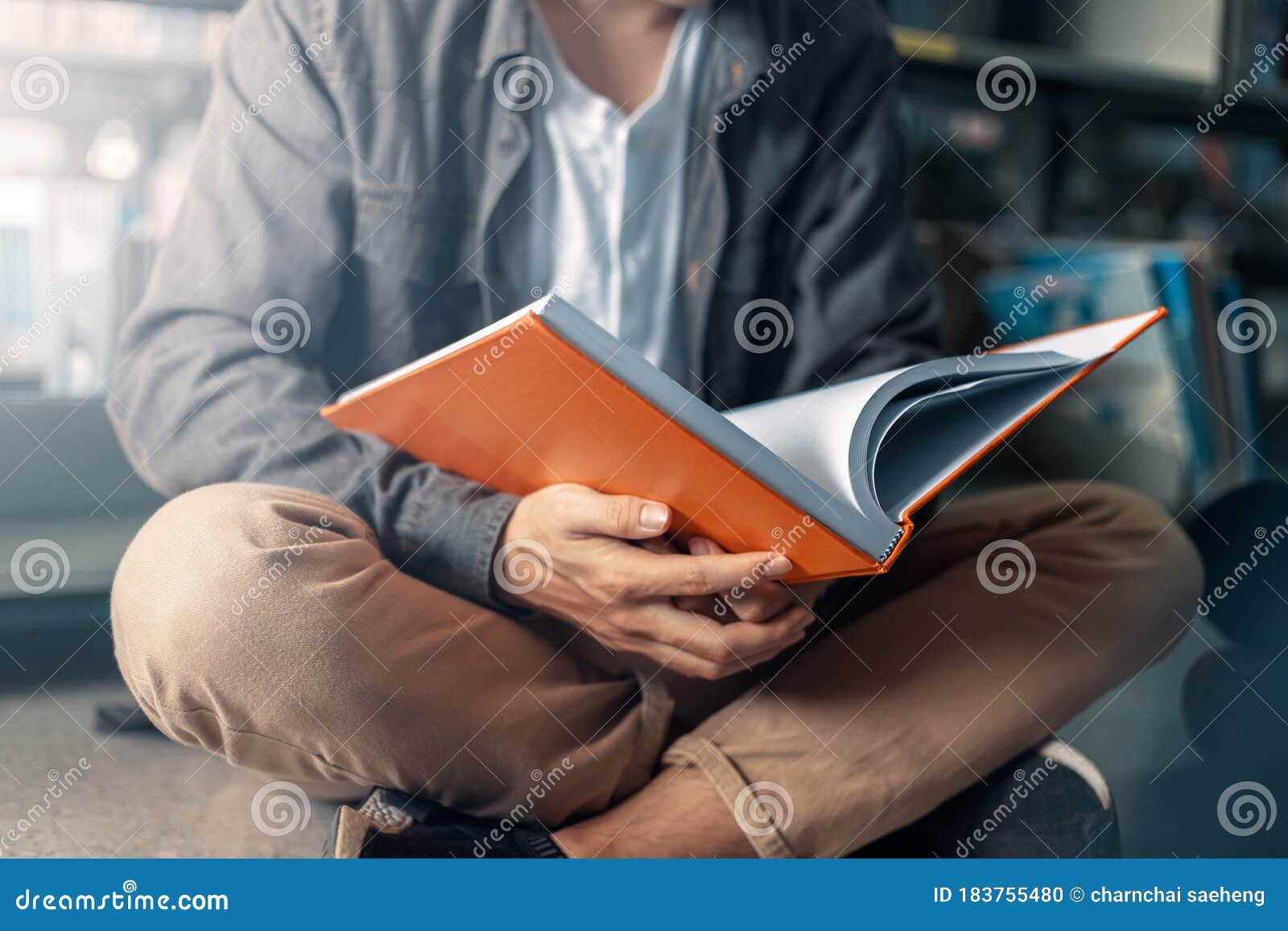 A Man Hands Opening and Reading a Book at Library Stock Photo - Image ...