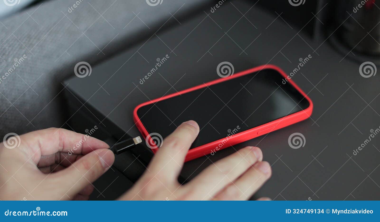 Man Hands Plugging a Charger in a Smartphone on Bedside Table. Mobile ...