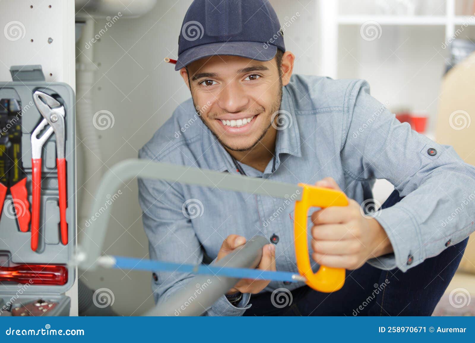 Man handsawing pipes stock image. Image of mount, piping - 258970671