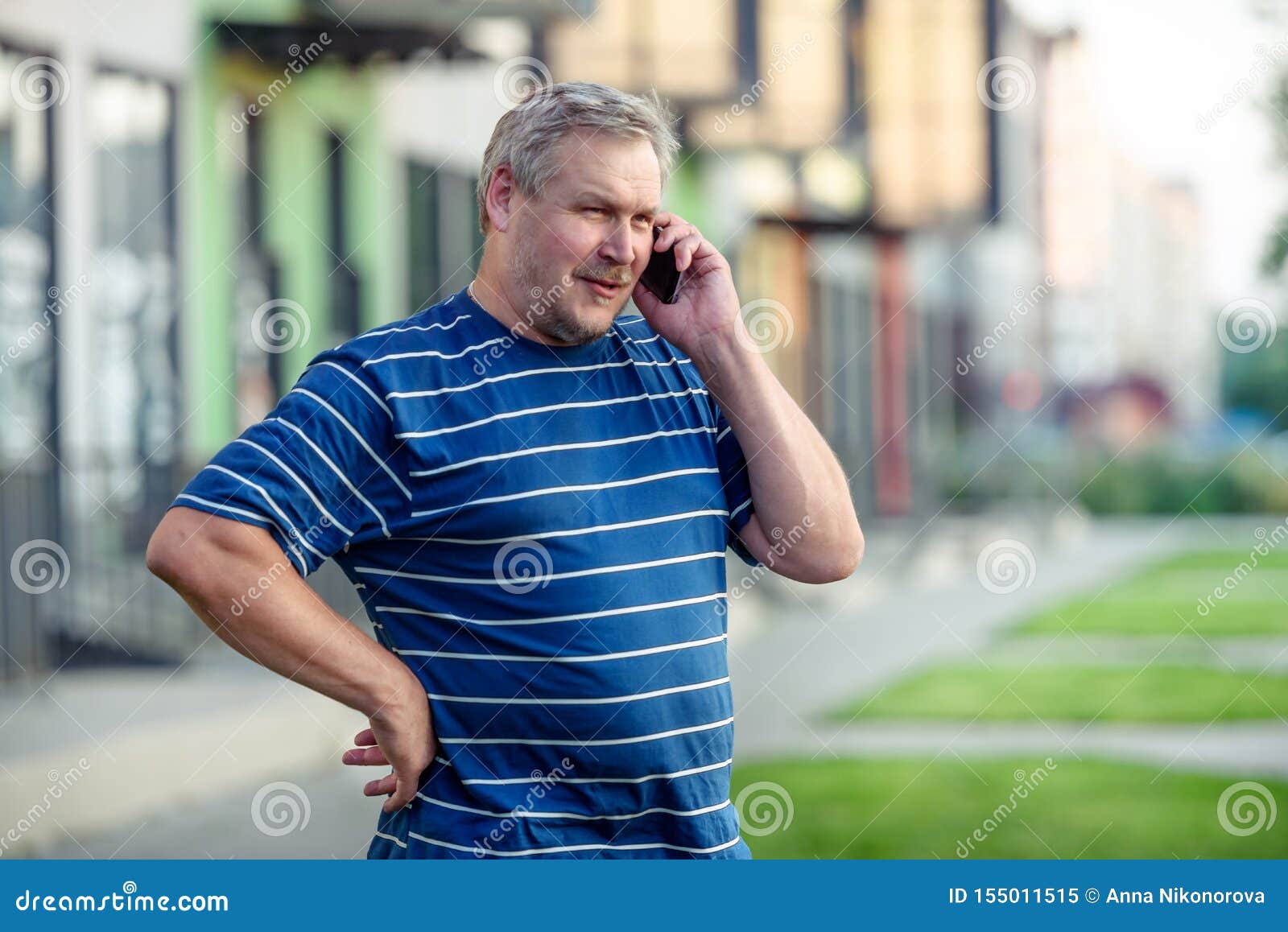 Man Happily Talking on a Smartphone while Walking on the Street. Stock ...