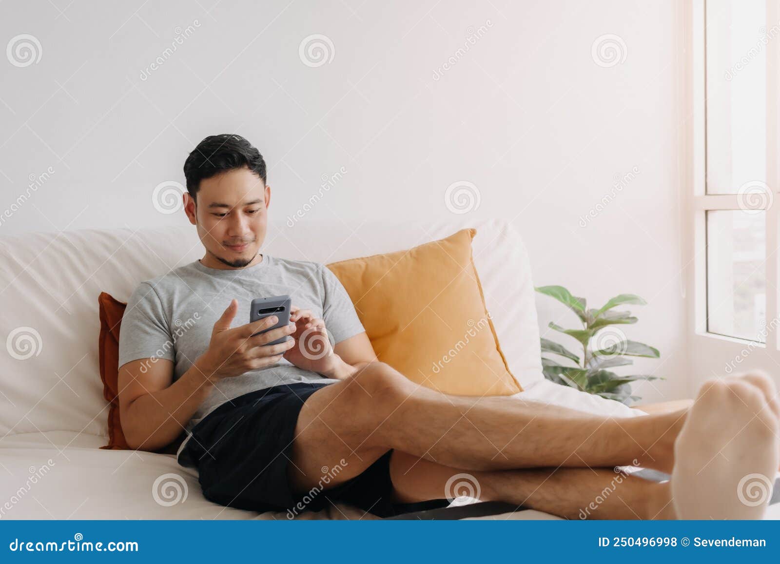 Man Happy with the Mobile Application while Relax on His Sofa. Stock ...