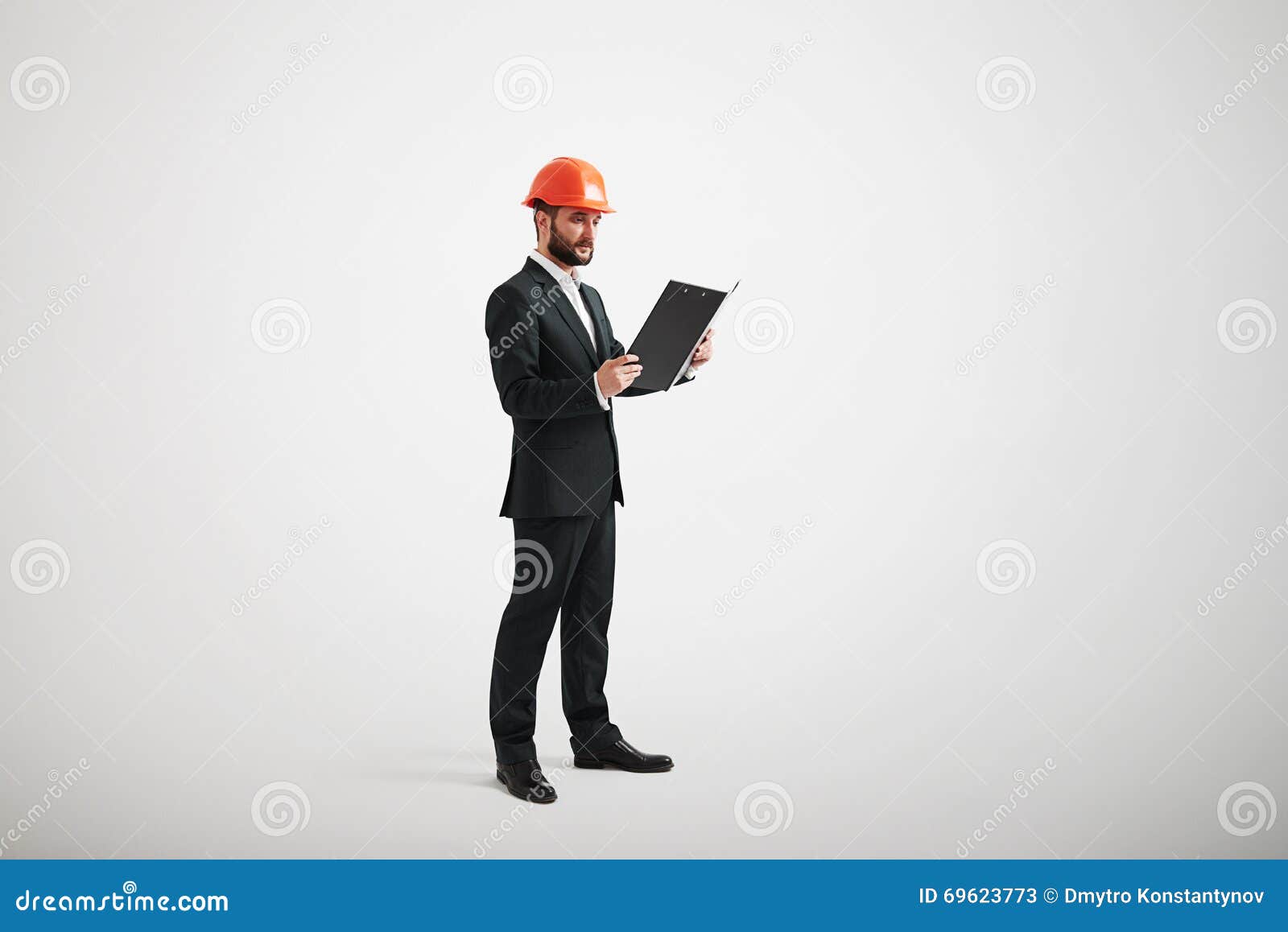 Man in Hard Hat Looking at Black Folder in His Arms Stock Image - Image ...