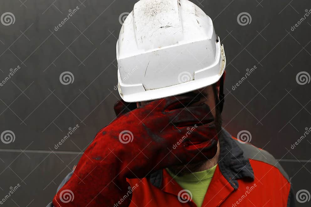 Man in a Hard Hat Shielding His Face with His Hand Stock Image - Image ...