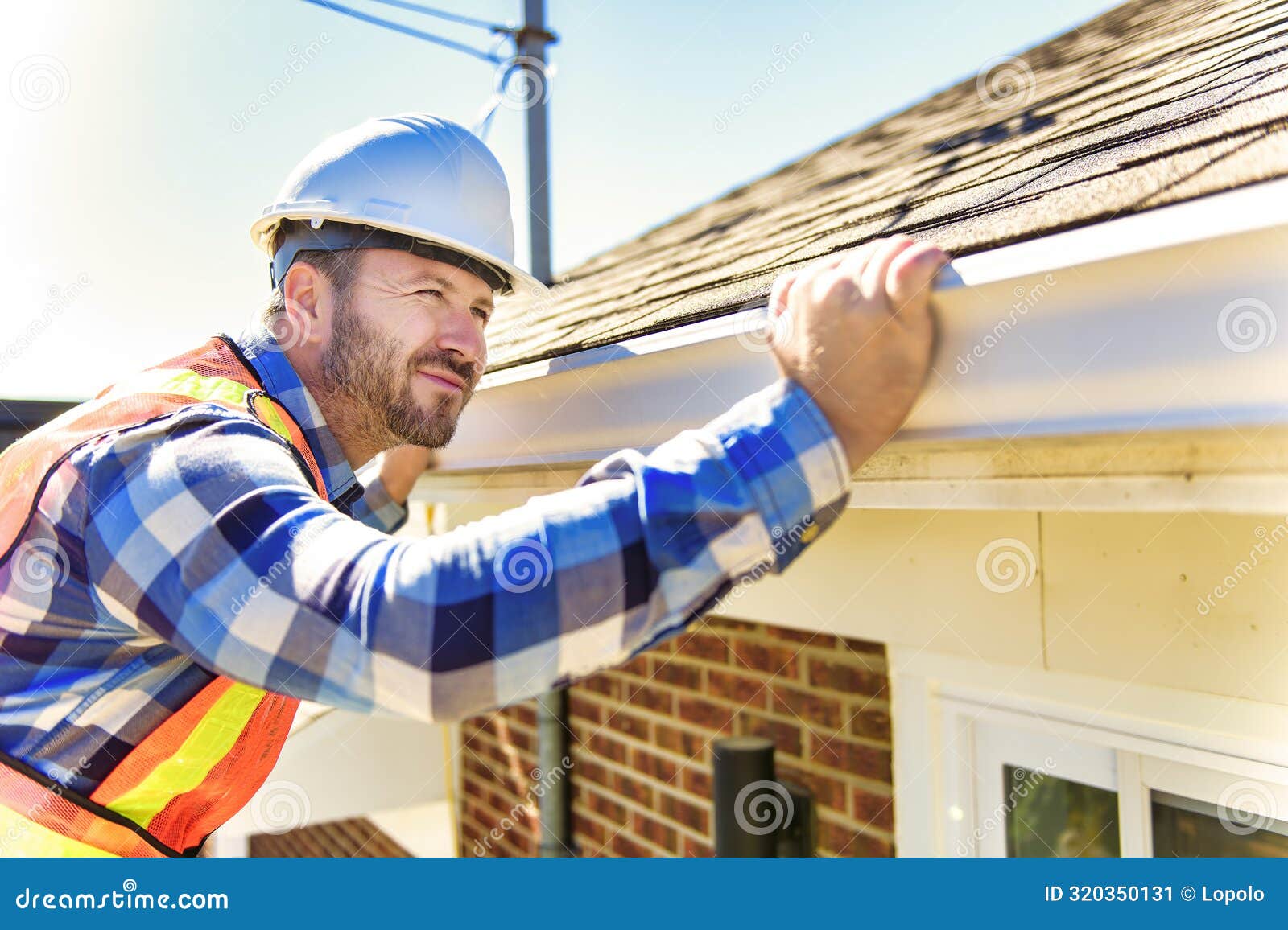Man with Hard Hat Standing on Steps Inspecting House Roof Stock Image ...