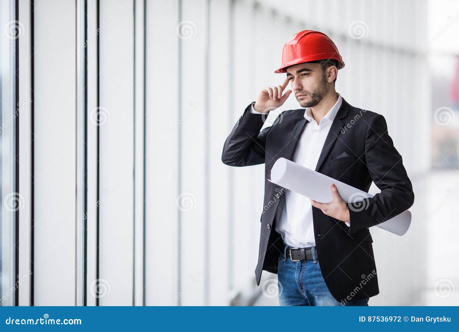 Man in Hard Hats at Building with Plans Thinking Stock Photo - Image of ...