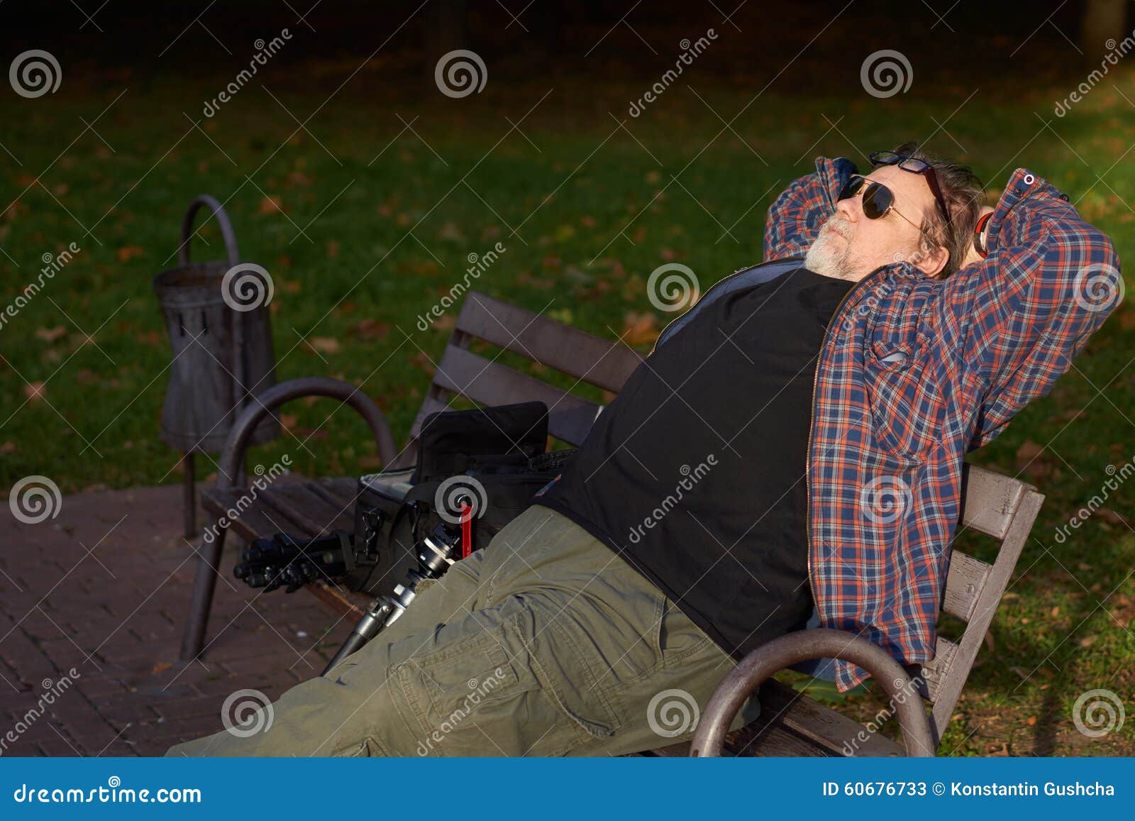 Man has rest on the bench stock image. Image of lawn - 60676733