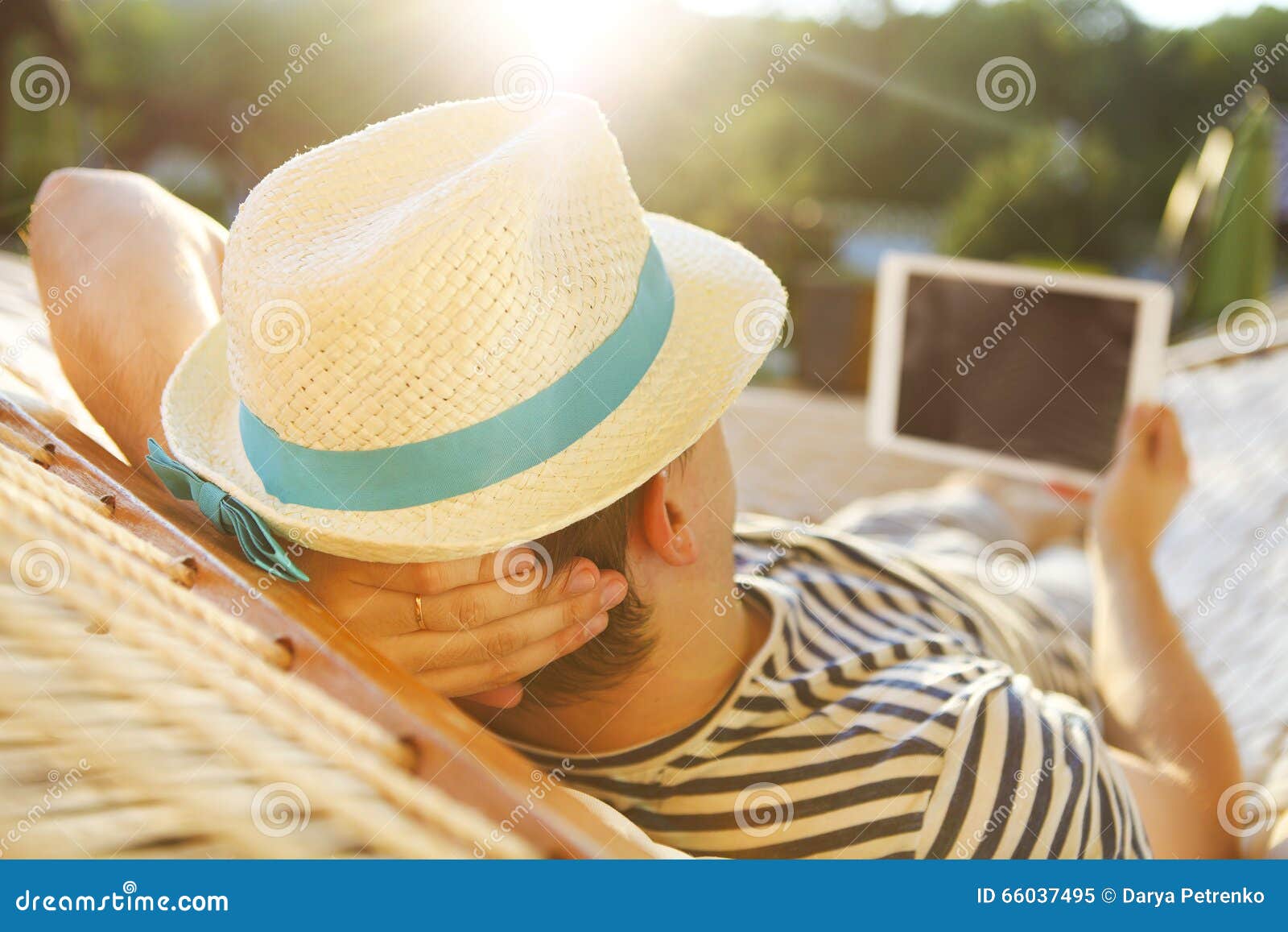 Man in Hat in a Hammock with Tablet Computer on a Summer Day Stock ...