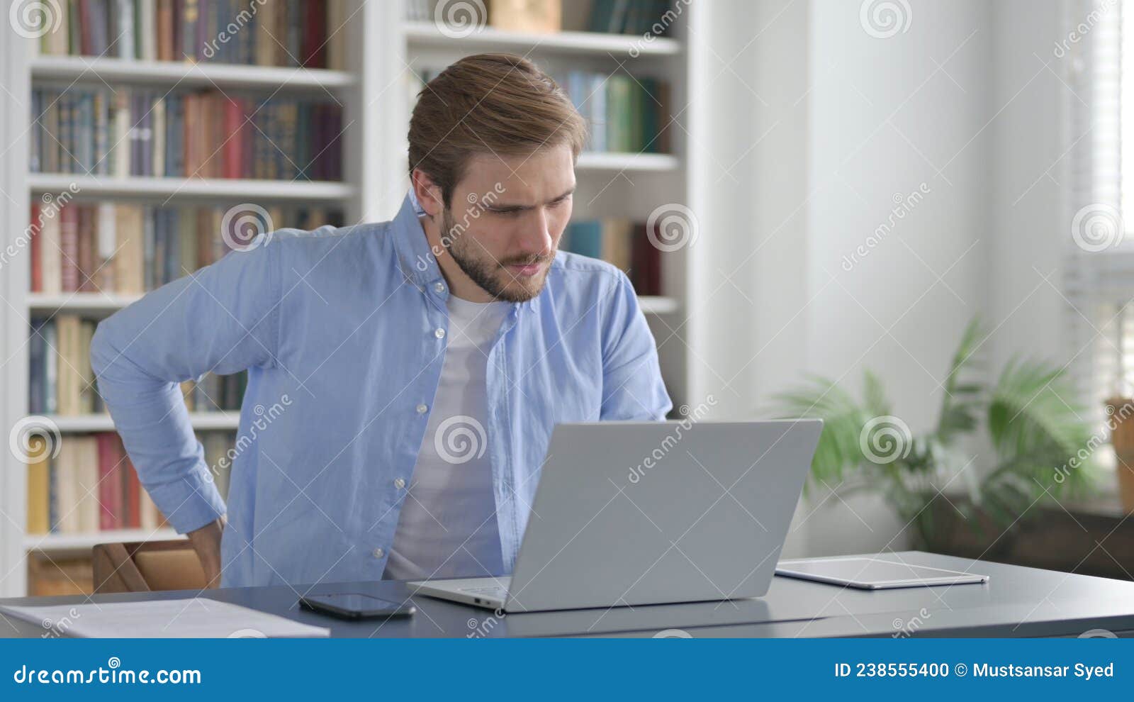 Man Having Back Pain while Using Laptop in Office Stock Photo - Image ...